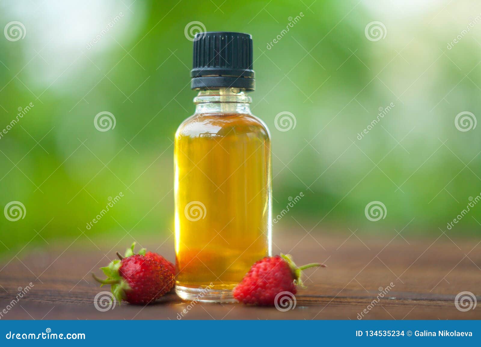 Essence of Wild Strawberry on Table in Beautiful Glass Jar Stock Photo ...