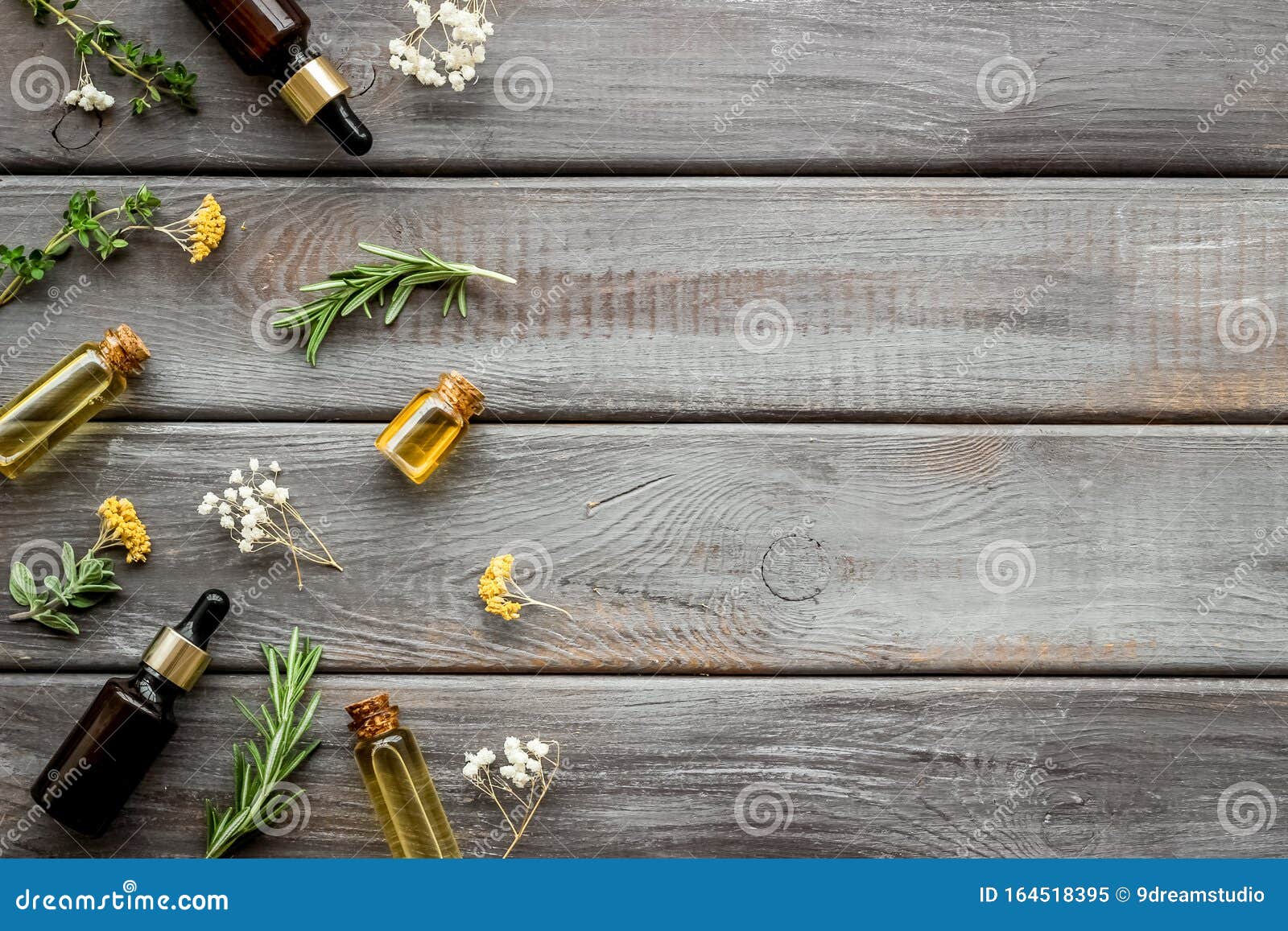 Essential Oils and Fresh Herbs on Dark Wooden Background Top View ...