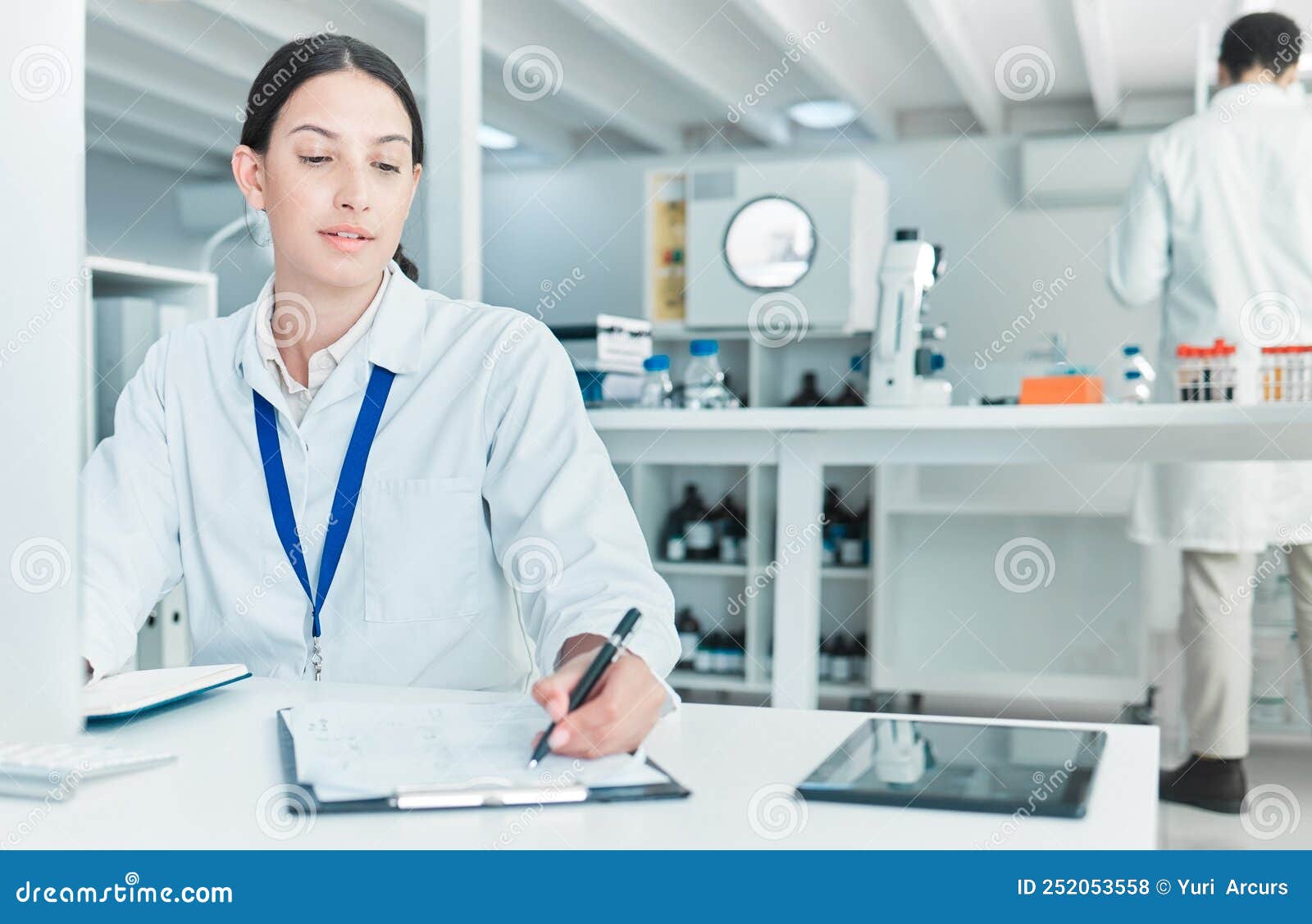 Establishing Reliable Facts. a Young Scientist Writing Notes while ...