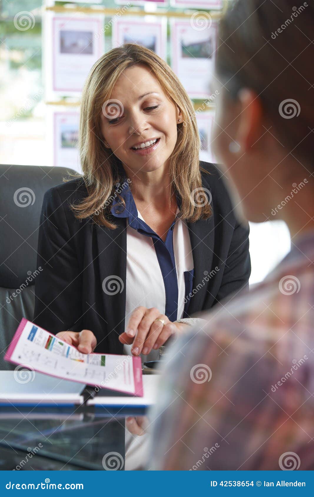 Estate Agent Discussing Property with Client in Office Stock Photo ...