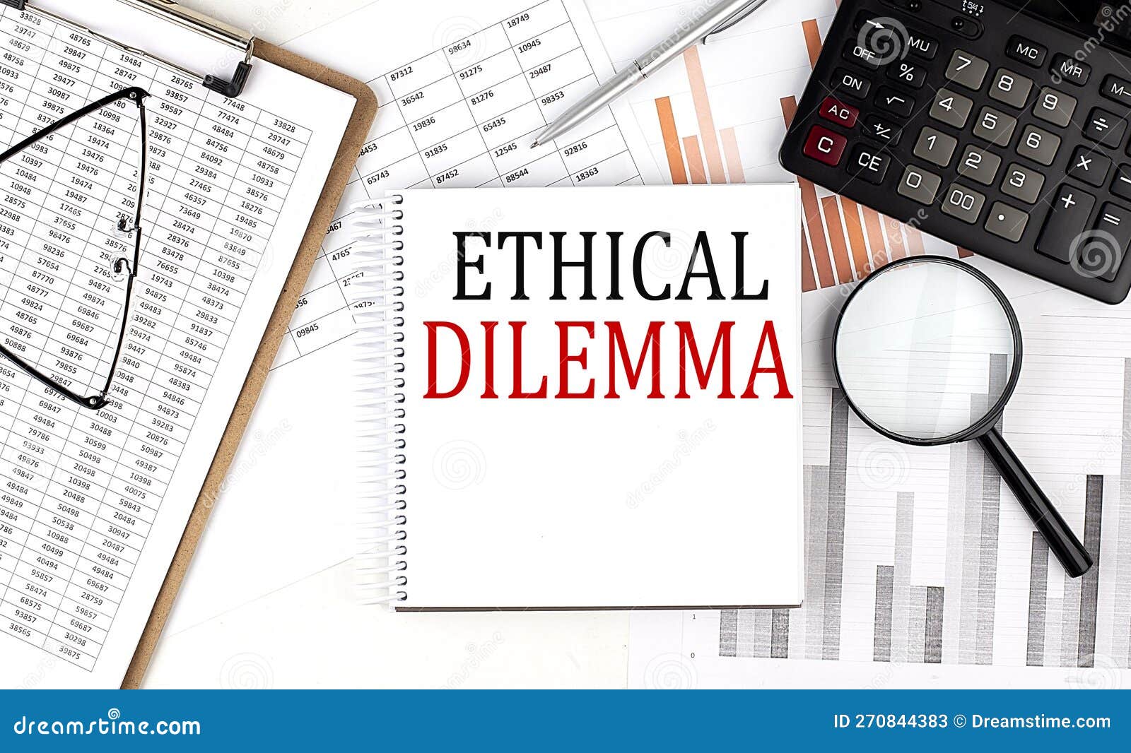 ETHICAL DILEMMA Text on Notebook with Clipboard and Calculator on a ...