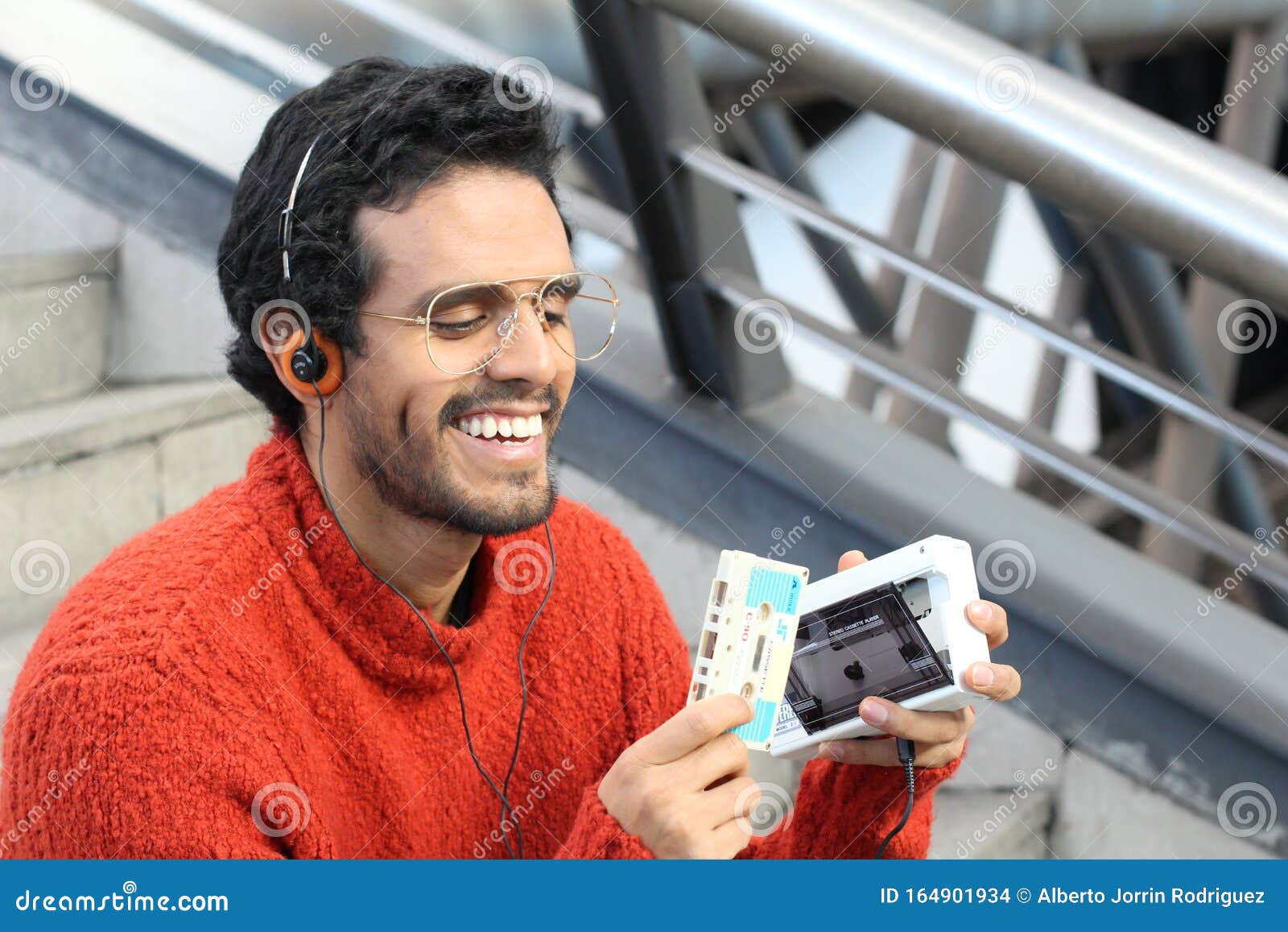 Ethnic guy using a walkman stock photo. Image of cable - 164901934