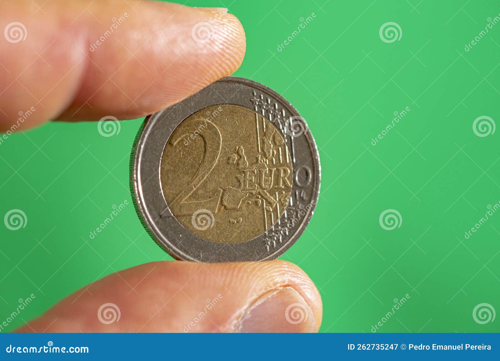 2 Euro Coin Face Held between Thumb and Index Finger. Stock Image ...
