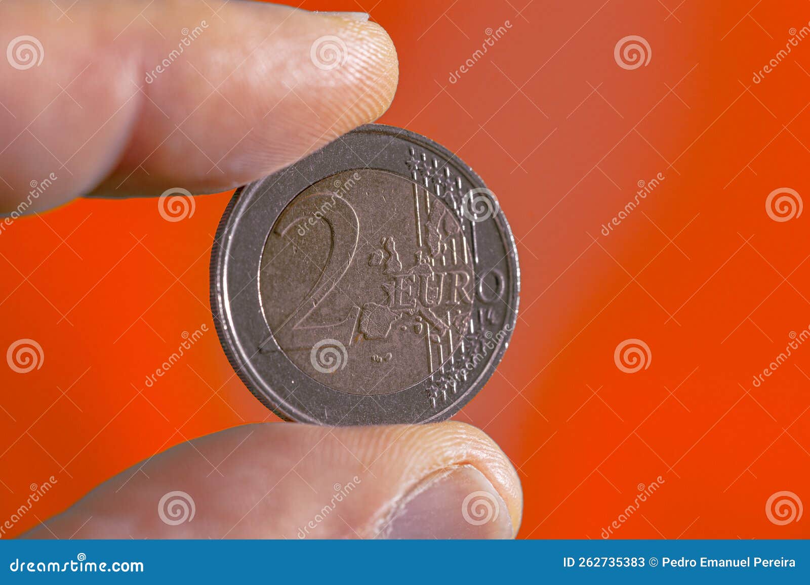 2 Euro Coin Face Held between Thumb and Index Finger. Stock Image ...