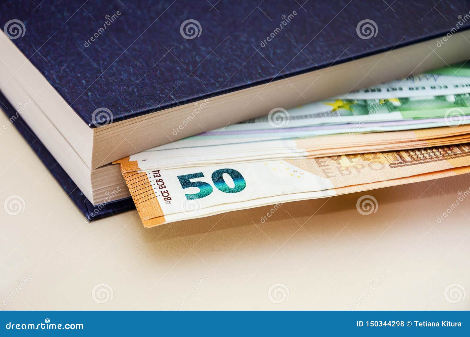 50 and 100 Euros in a Book on the Table, Close-up Stock Photo - Image ...