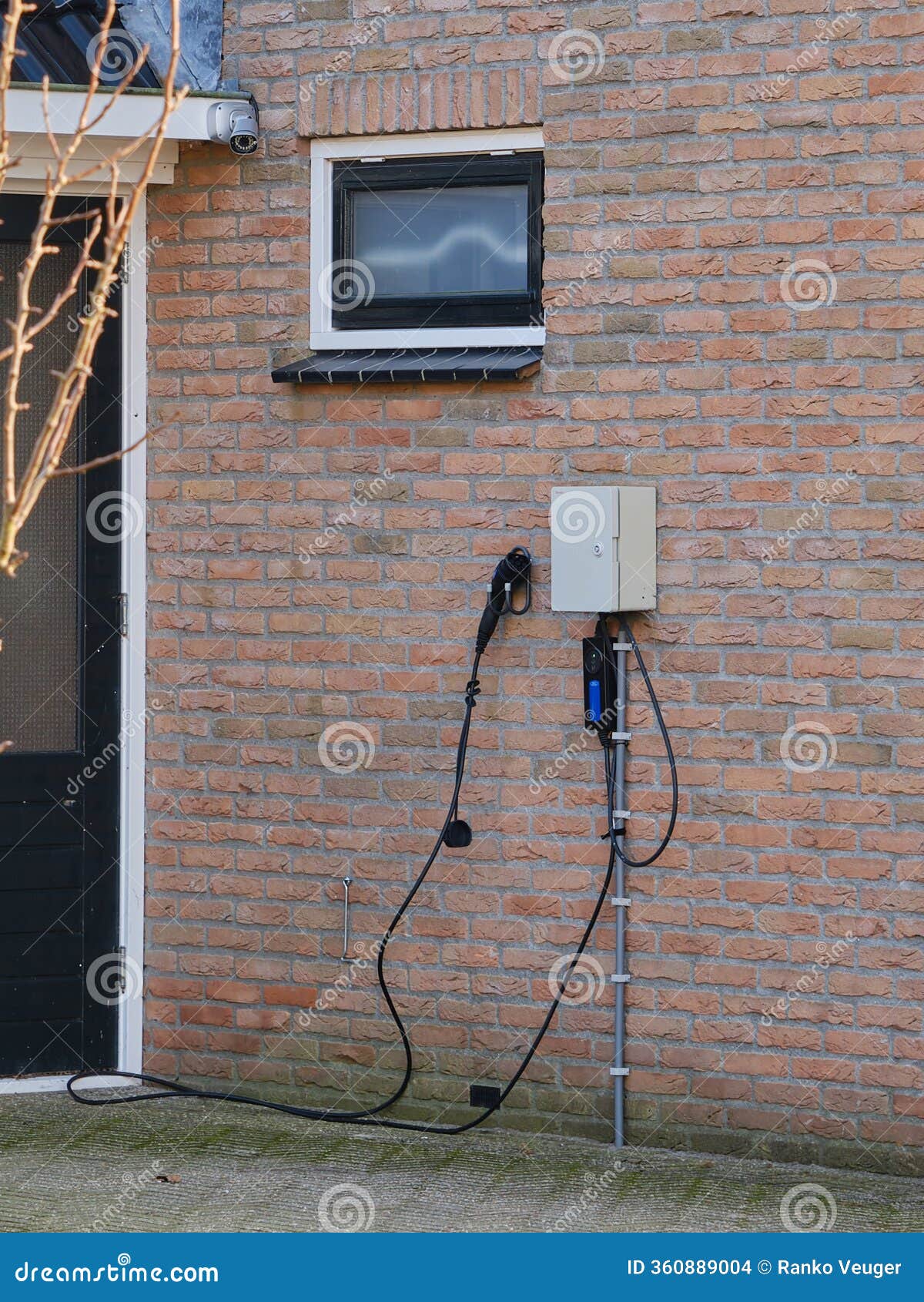 EV Charger on Brick Wall with Security Camera and Window View Stock ...