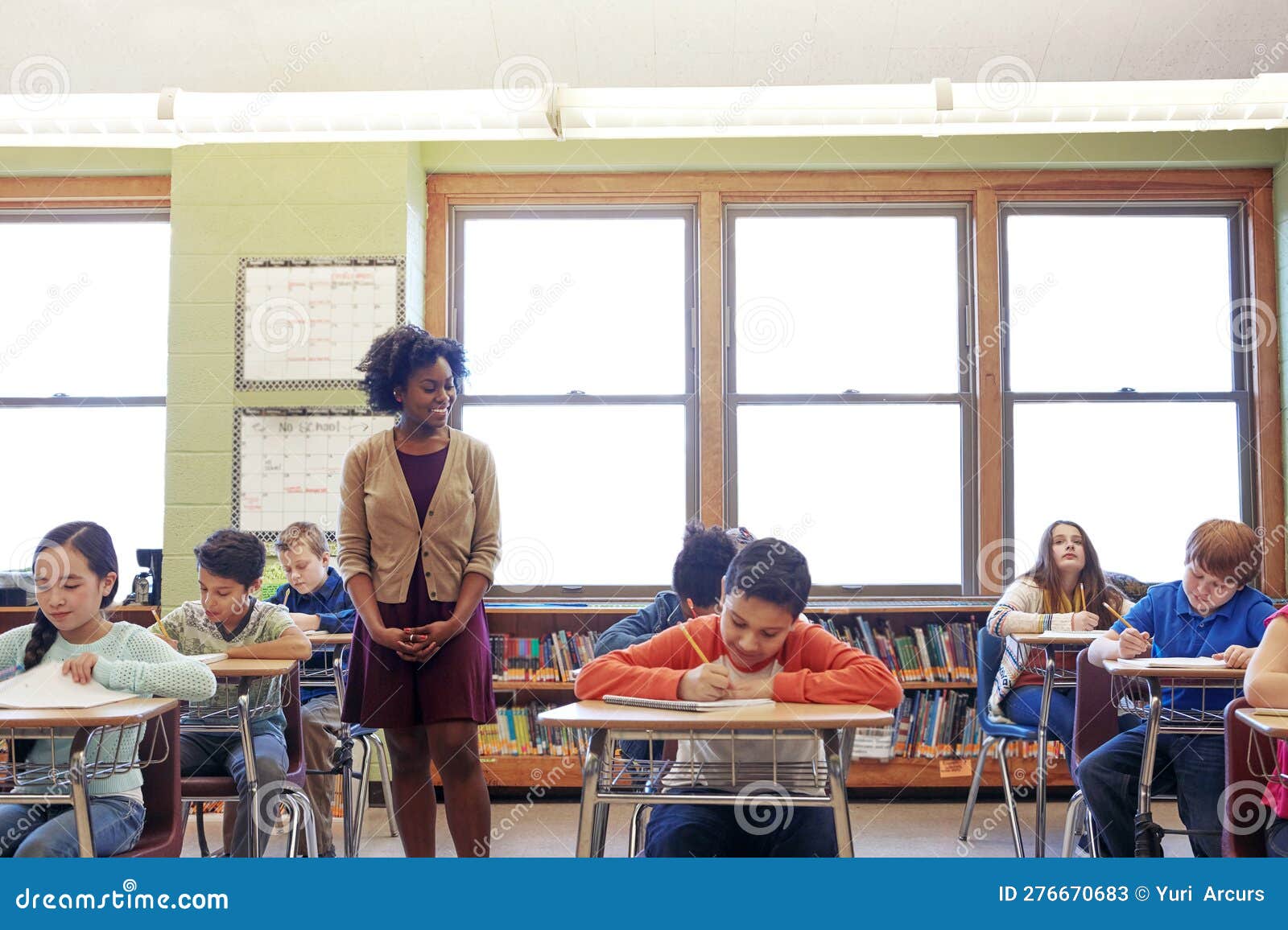 Evaluating Their Progress. a Teacher in a Classroom with Her Students ...