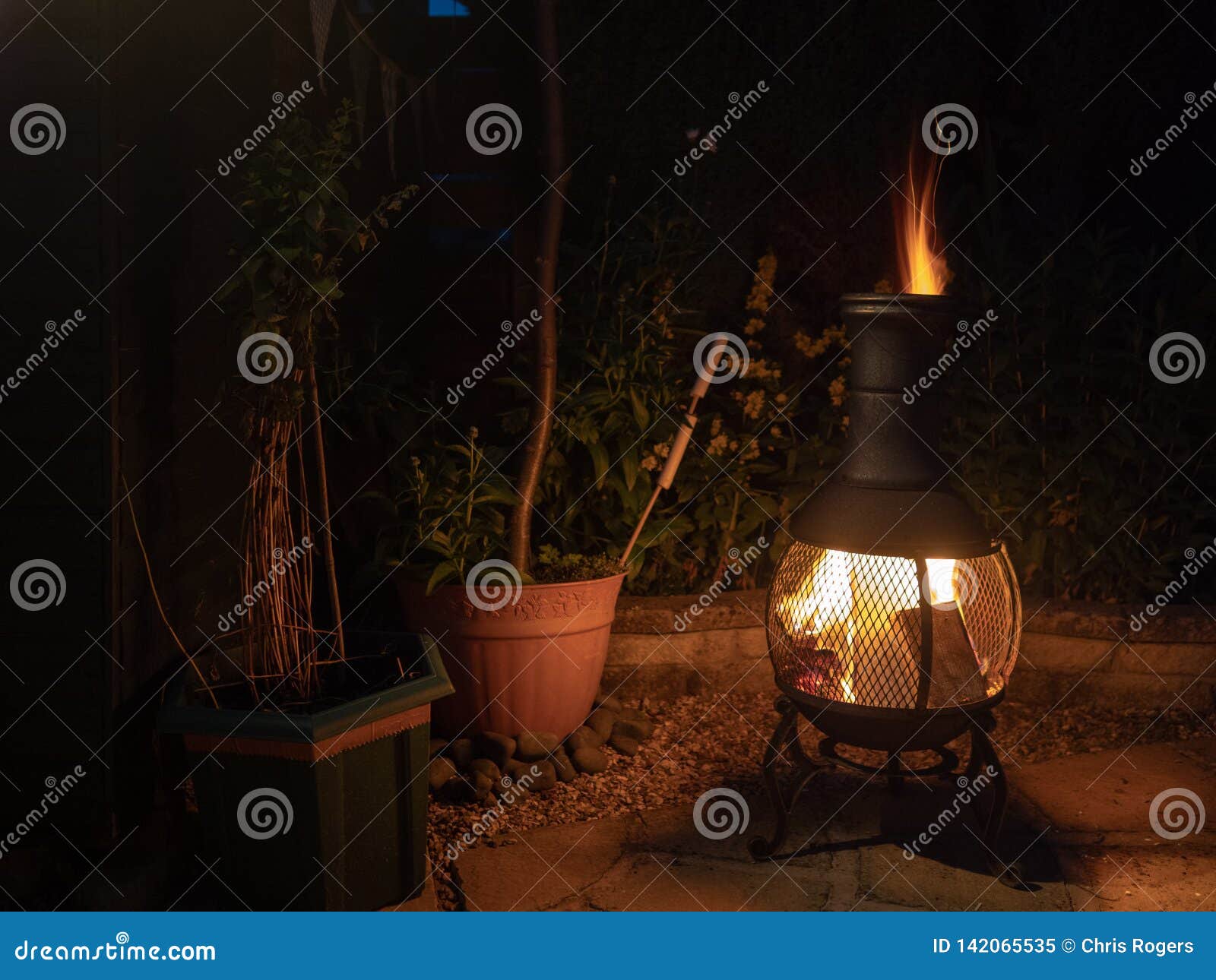 Evening Around the Garden Chiminea Stock Image - Image of candle, flame ...