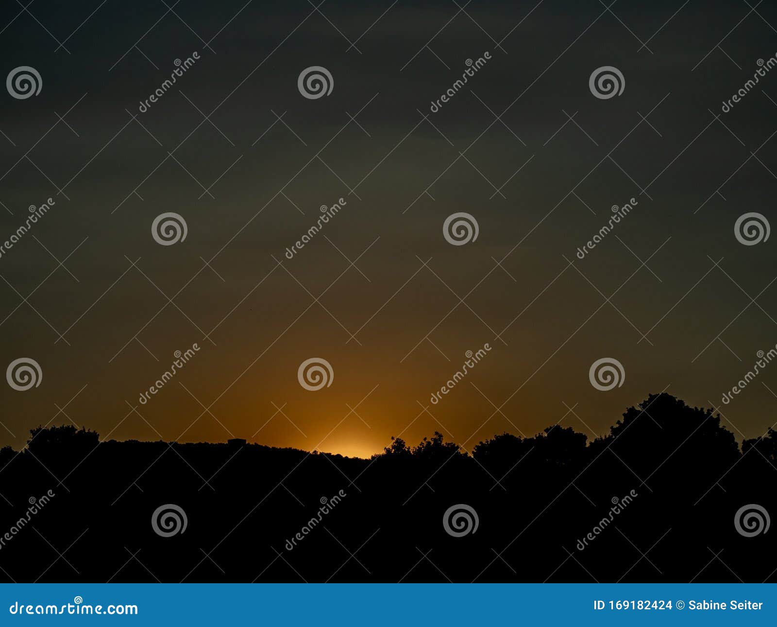 Sunset Behind Hills and Bushes Stock Photo - Image of dramatic, bushes ...