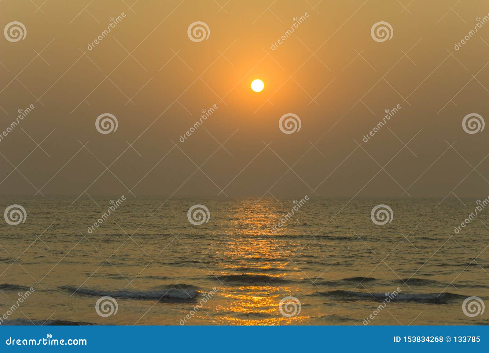 Evening Ocean with a Sun Path and Waves Against a Yellow, Purple Sunset ...