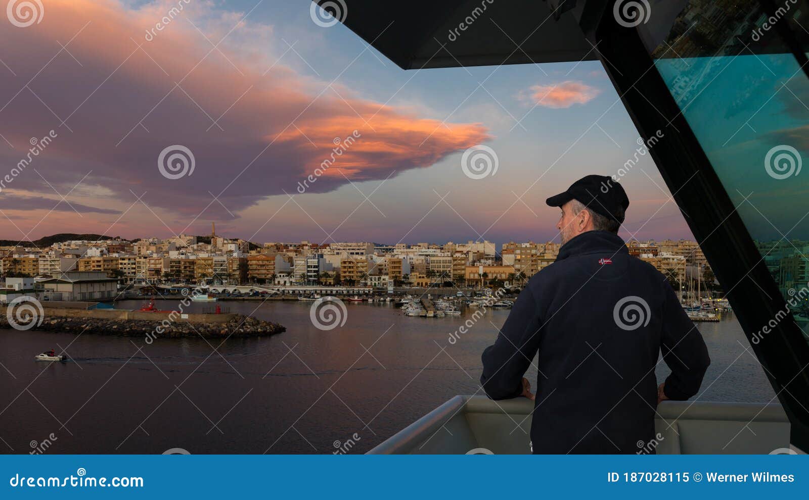 In the Evening in a Port. the Captain of a Cargo Ship Stands on the ...