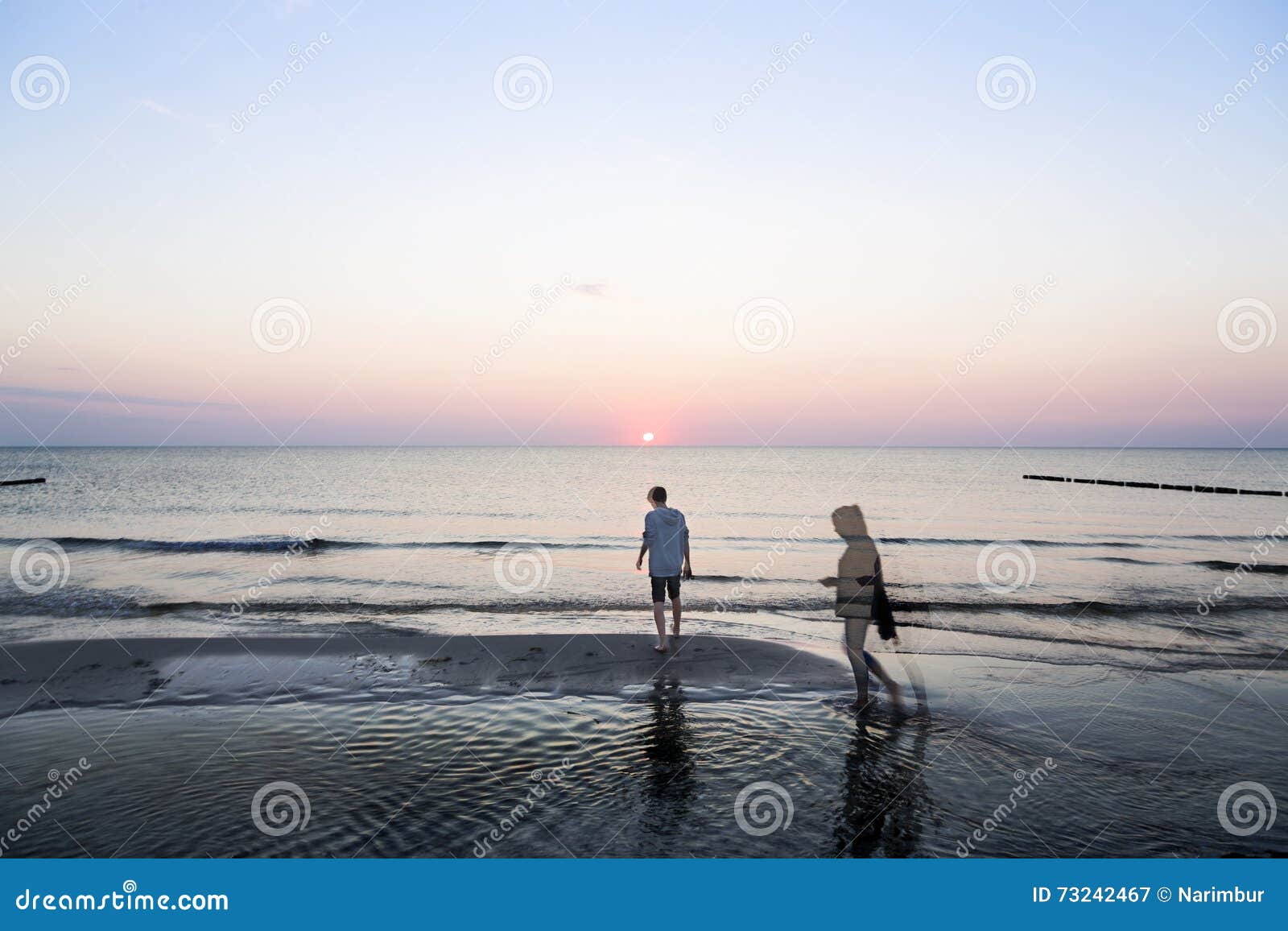 Evening walk at the beach stock image. Image of blurred - 73242467