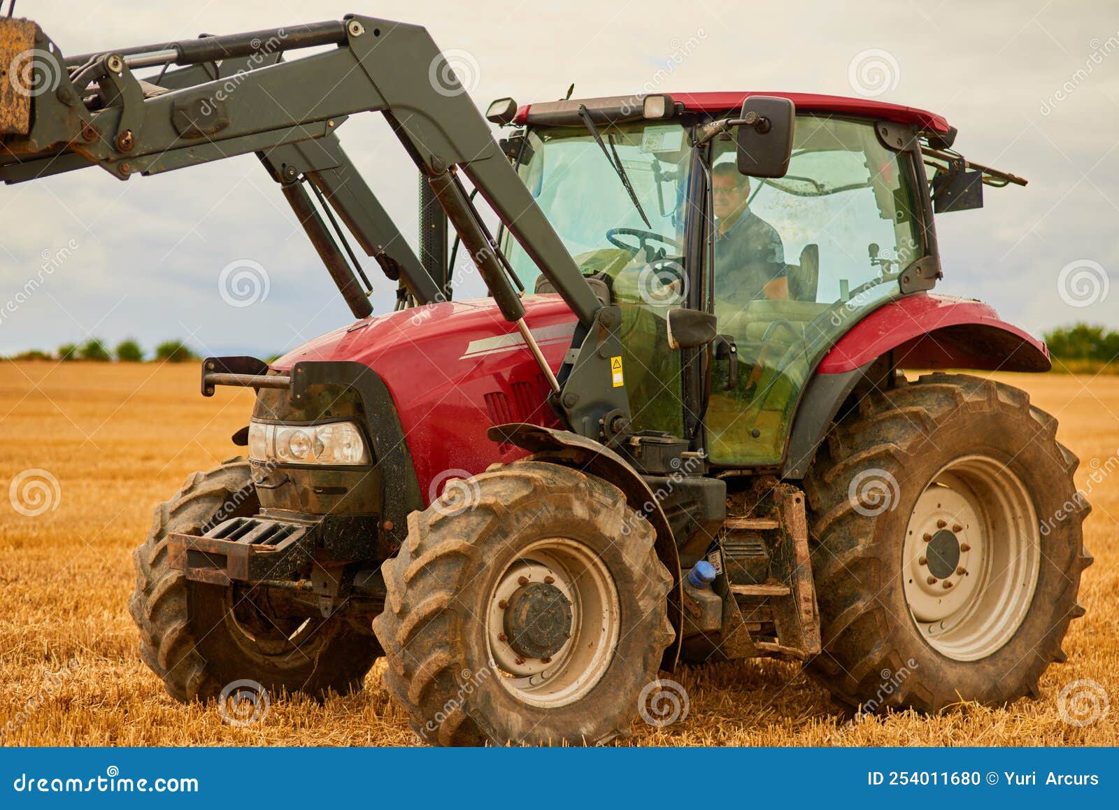 Every Farm Needs a Tractor. a Farmer Driving a Tractor Around His Farm ...