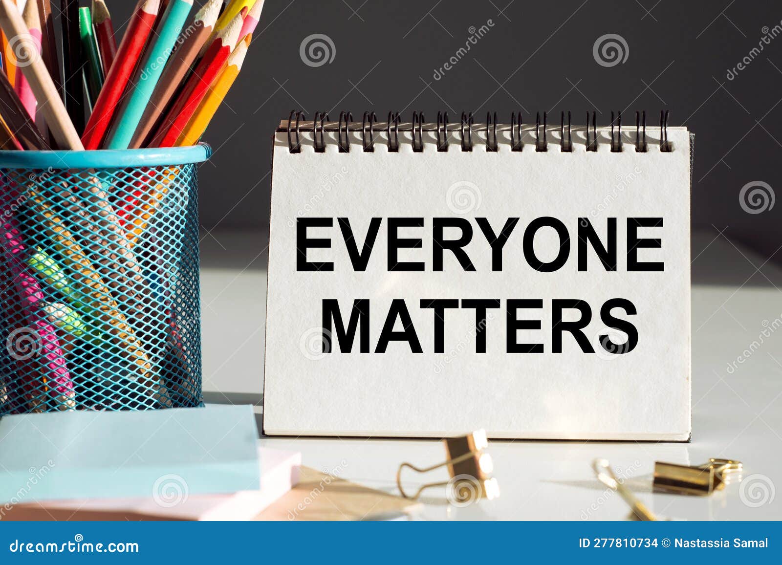 EVERYONE MATTERS is Written in White Notepad on Office Table. Business ...