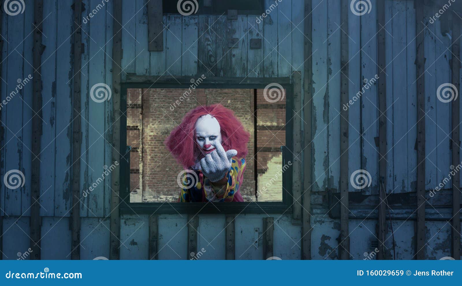 An Evil Clown Looks Out of a Window and Waves at You Stock Image ...