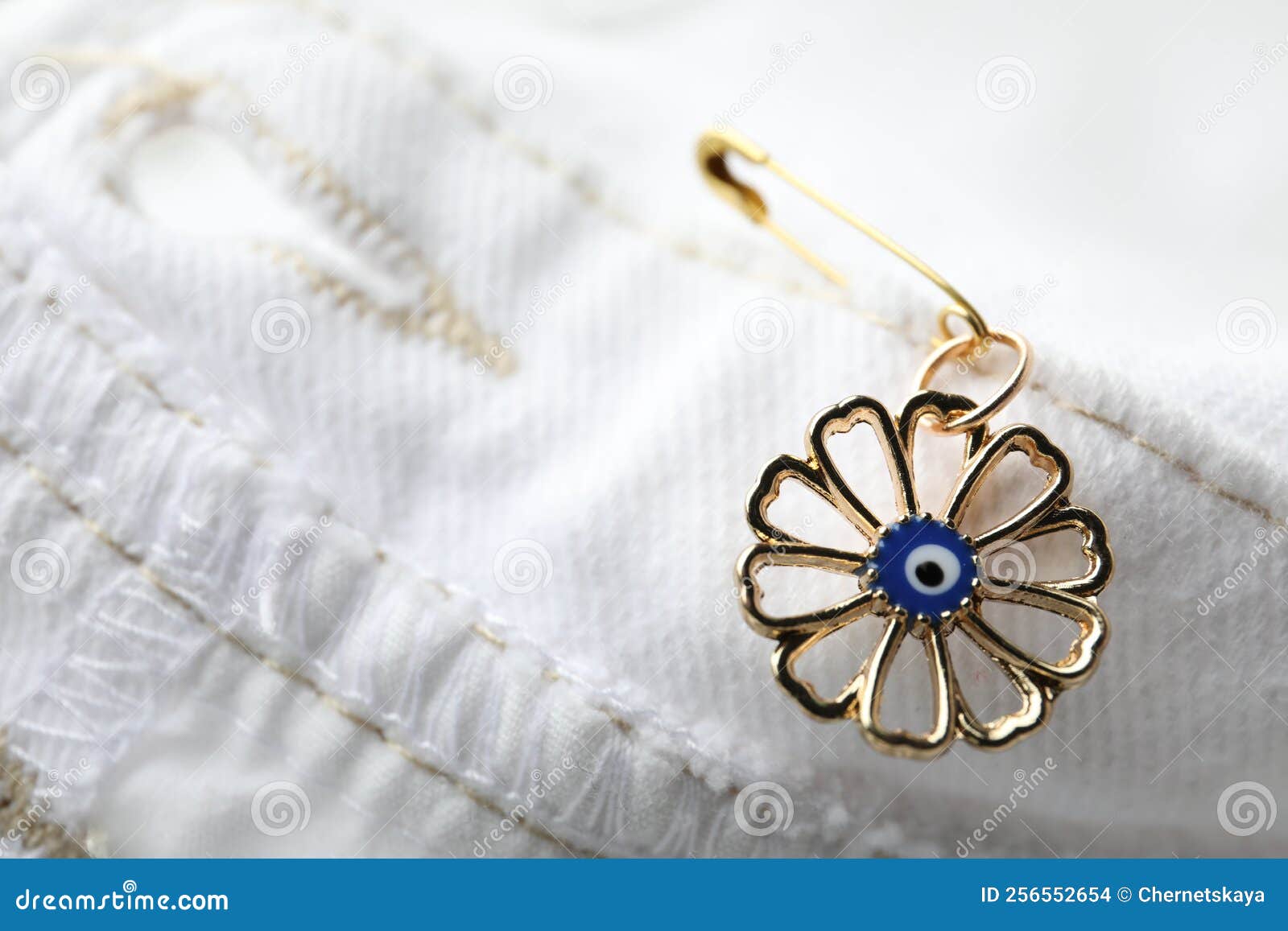 Evil Eye Safety Pin on Clothing, Closeup Stock Photo - Image of black ...