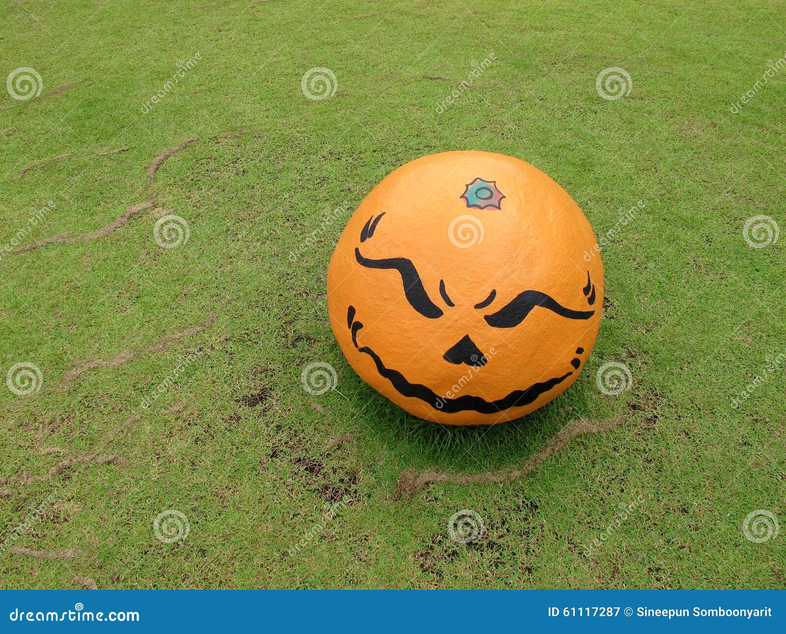 Evil Face on Orange Round Shape Rock Stock Image - Image of green ...