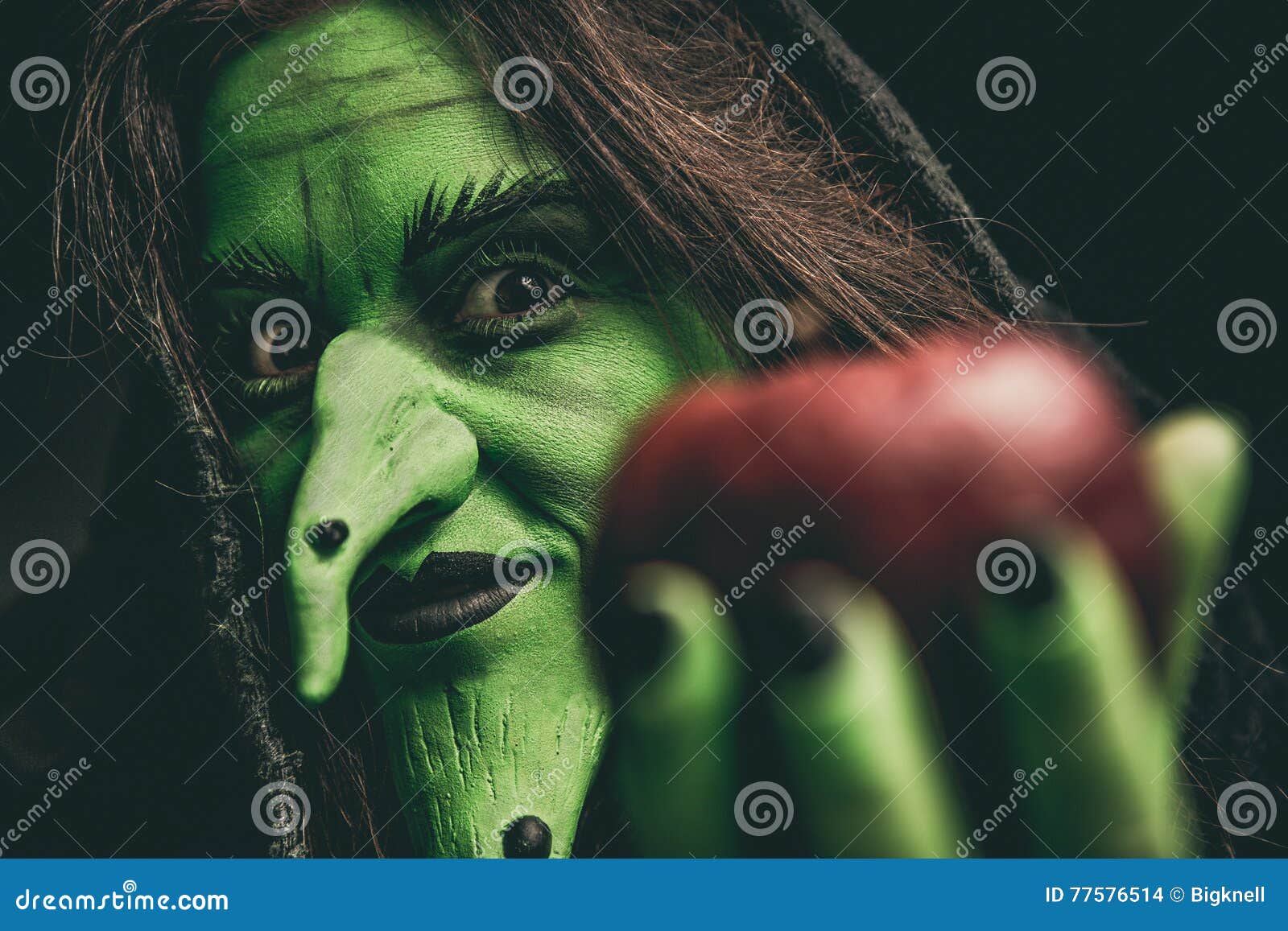 Evil Witch Looking at Camera Holding a Red Apple Stock Photo - Image of ...