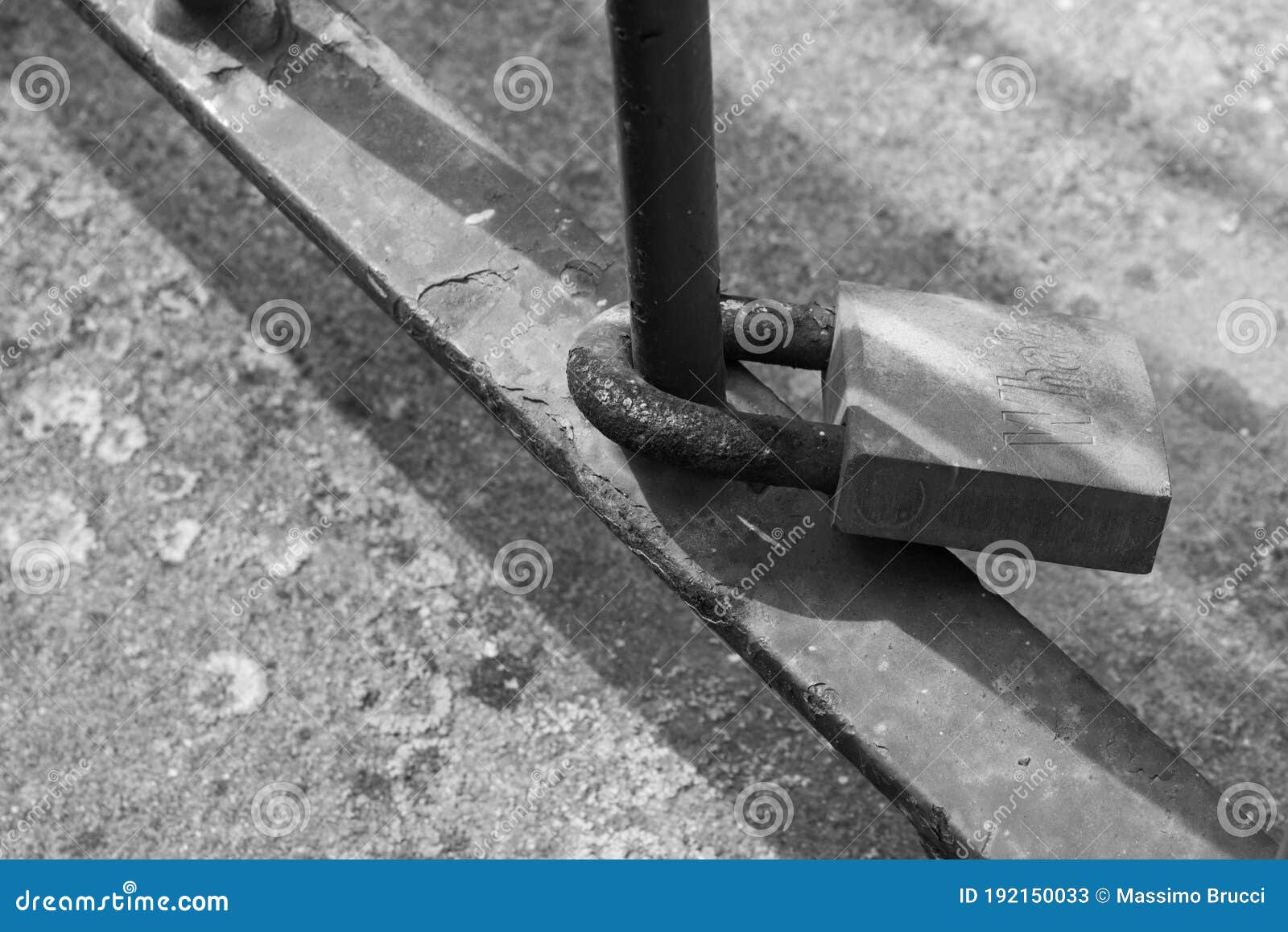 Black and White Image of a Padlock Tied To a Rusty Pole Stock Image ...