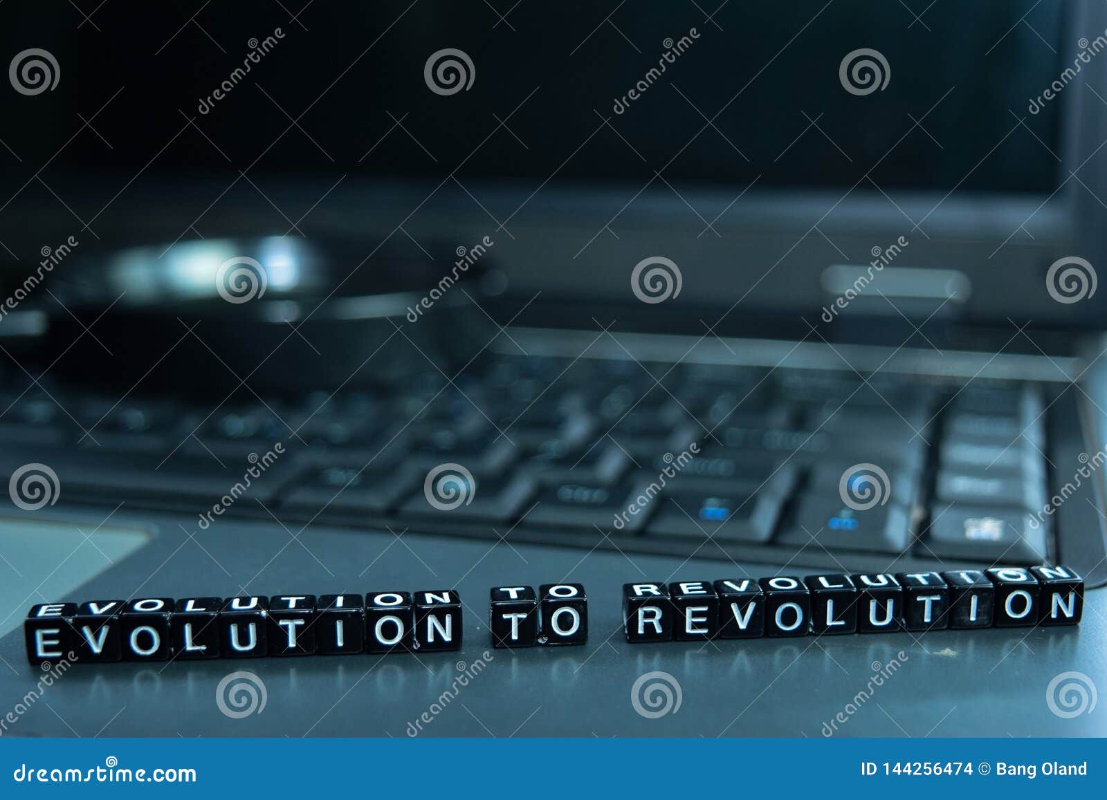Evolution To Revolution Text Wooden Blocks in Laptop Background ...
