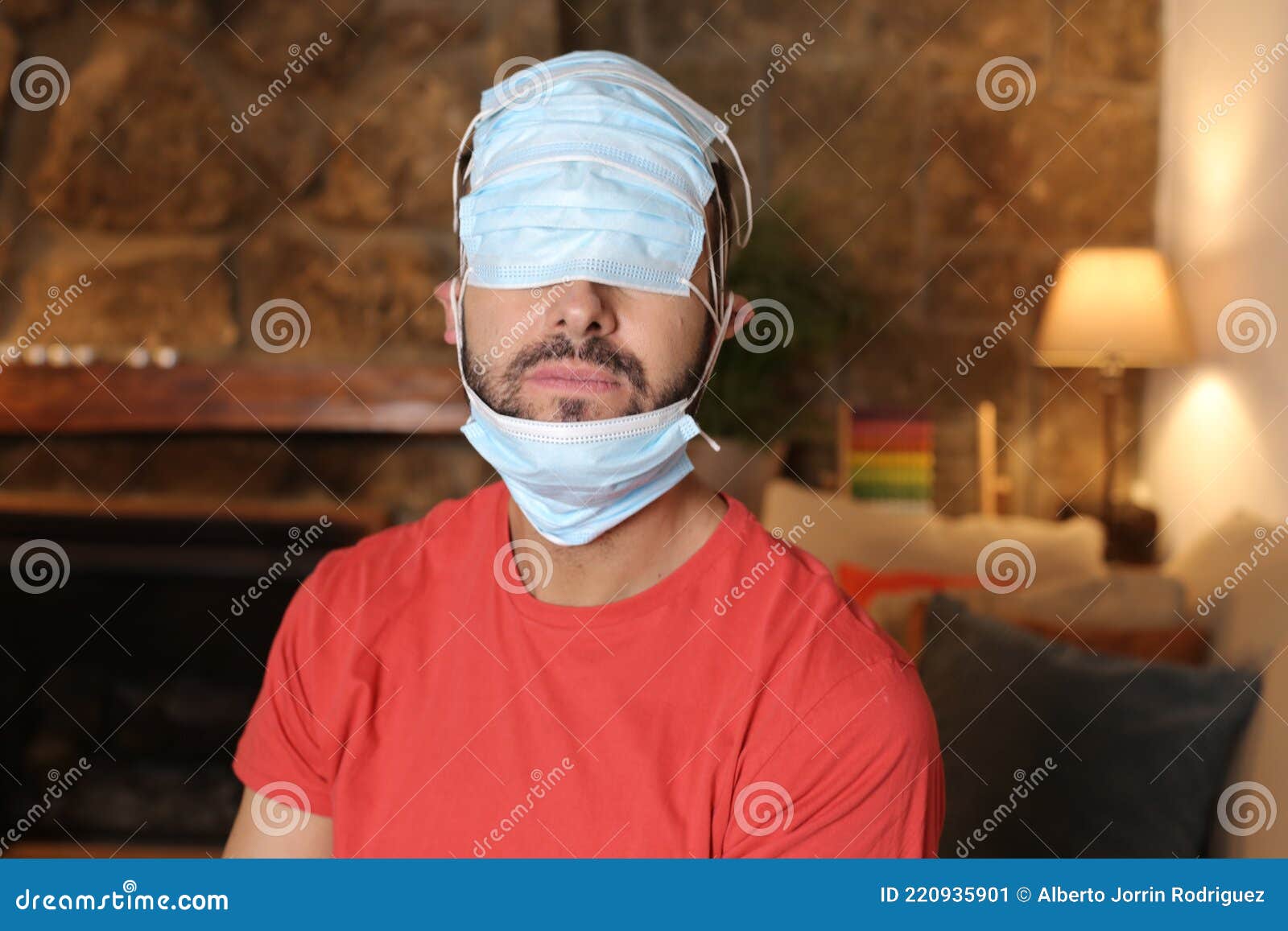 Exaggerated Man Covering His Head with Surgical Masks Stock Image ...