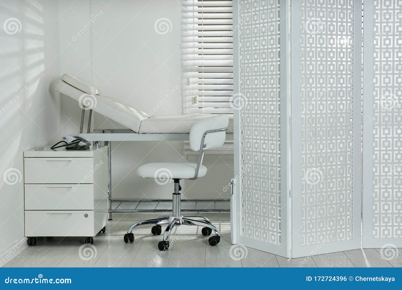 Examination Room with Couch and Folding Screen in Clinic Stock Photo ...