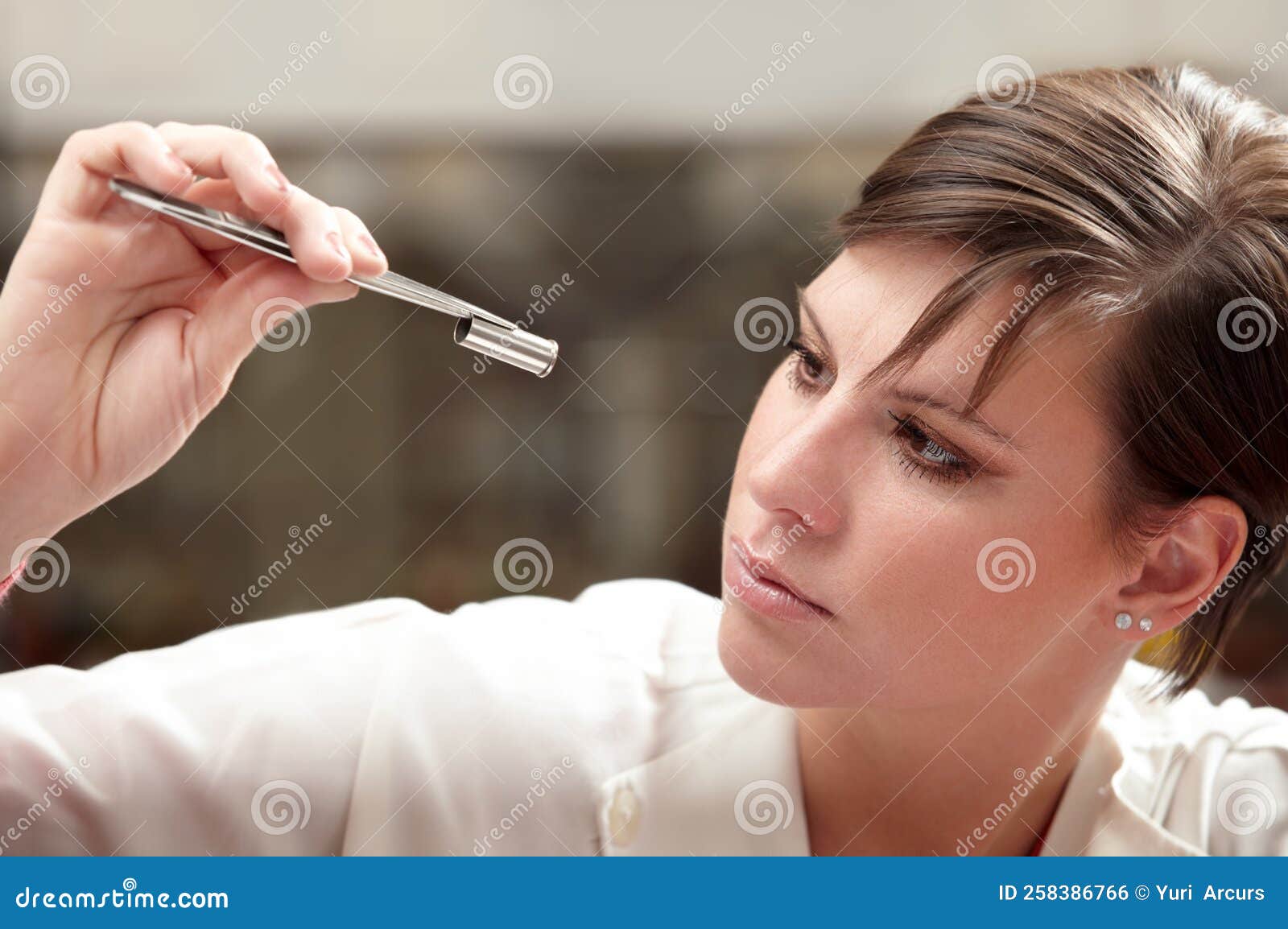 Examining Every Detail. a Forensic Expert Examining a Bullet Casing ...