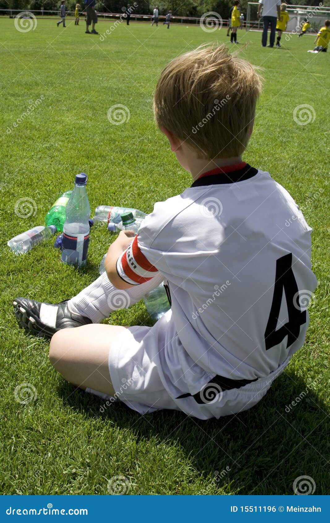 Exausted boy takes a rest stock photo. Image of kicking - 15511196