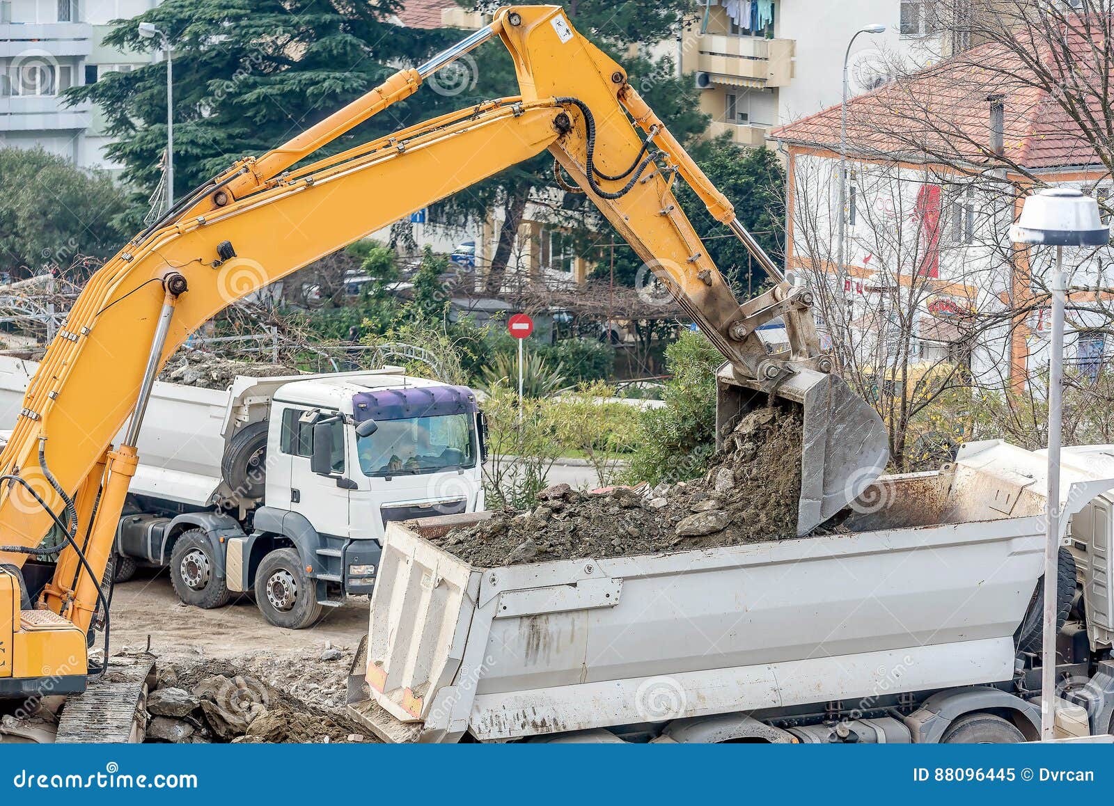 Exavator Loading Earth in the Truck on Construction Site Stock Image ...