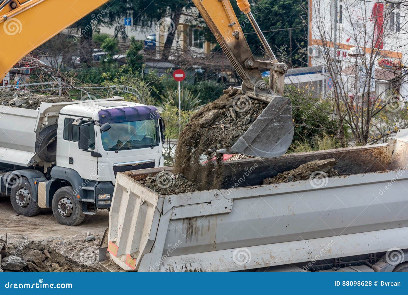 Exavator Loading Earth in the Truck on Construction Site Stock Photo ...