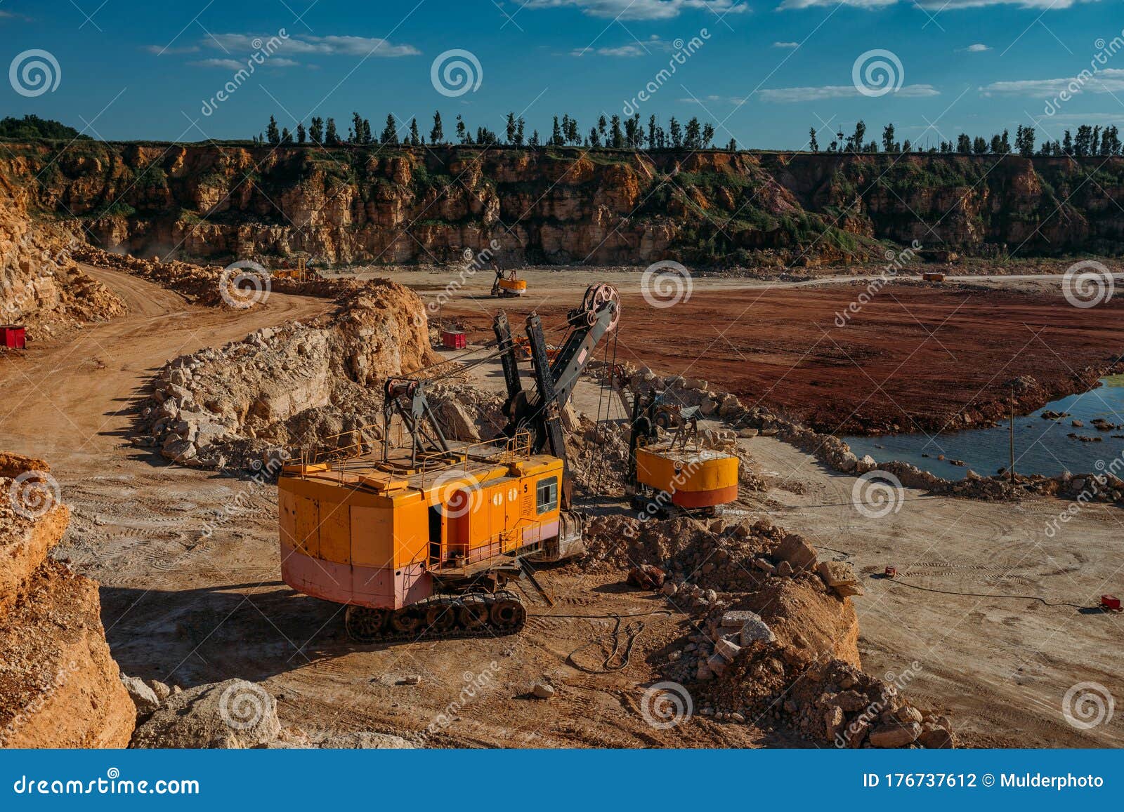 Excavarors Working on Limestone Mining in the Flooded Quarry Stock ...