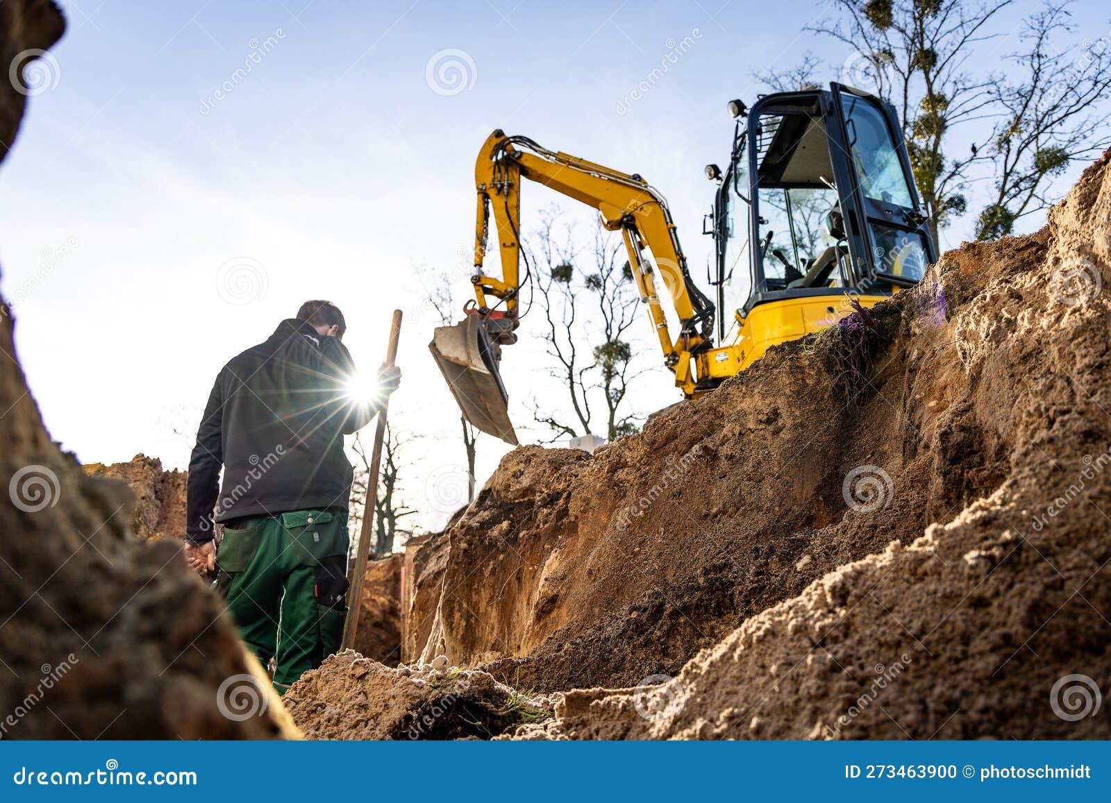Excavation and Earthwork at a Construction Site with a Person and ...
