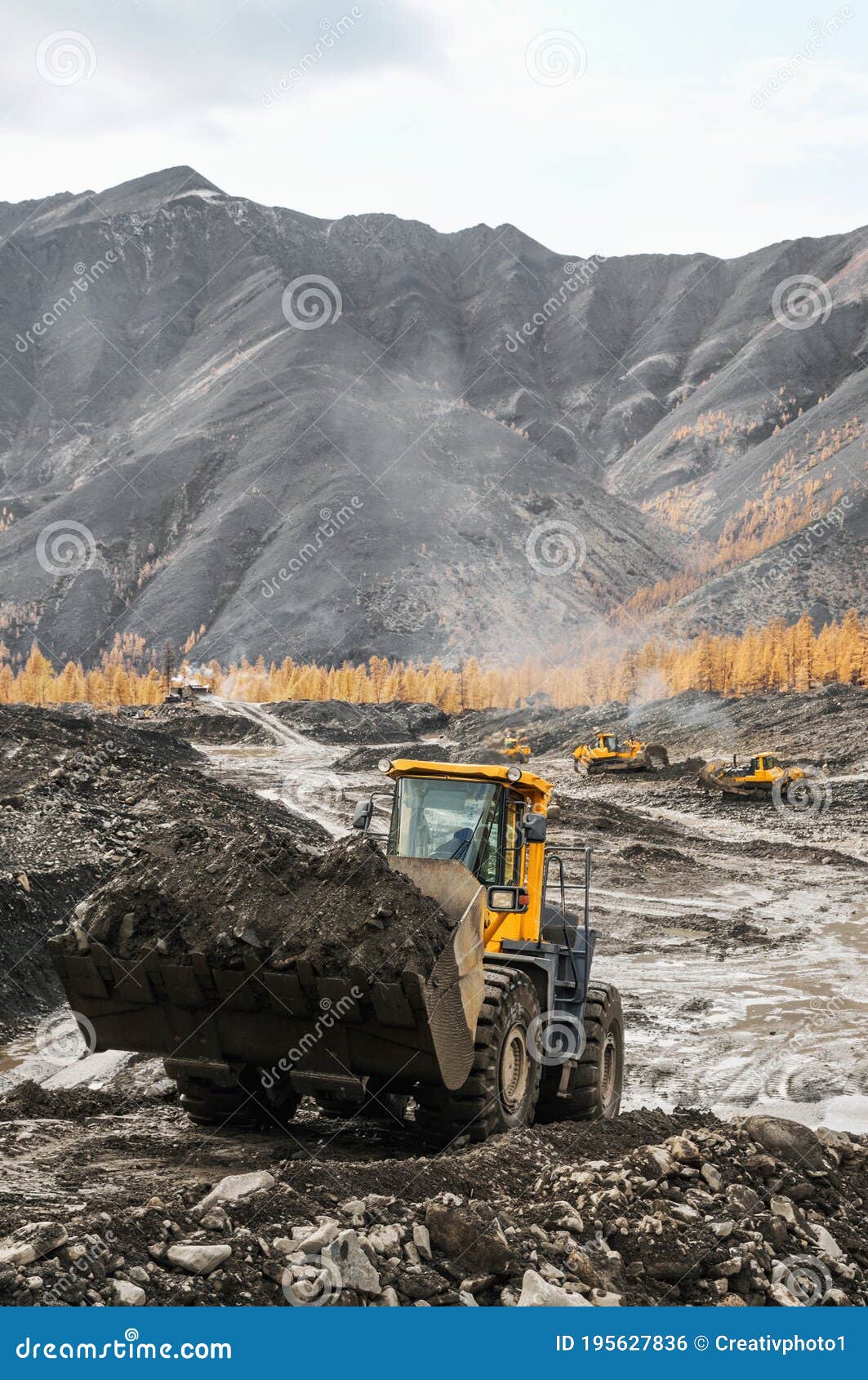 Excavation Work in a Mountainous Wooded Area. Wheel Loader at Work ...