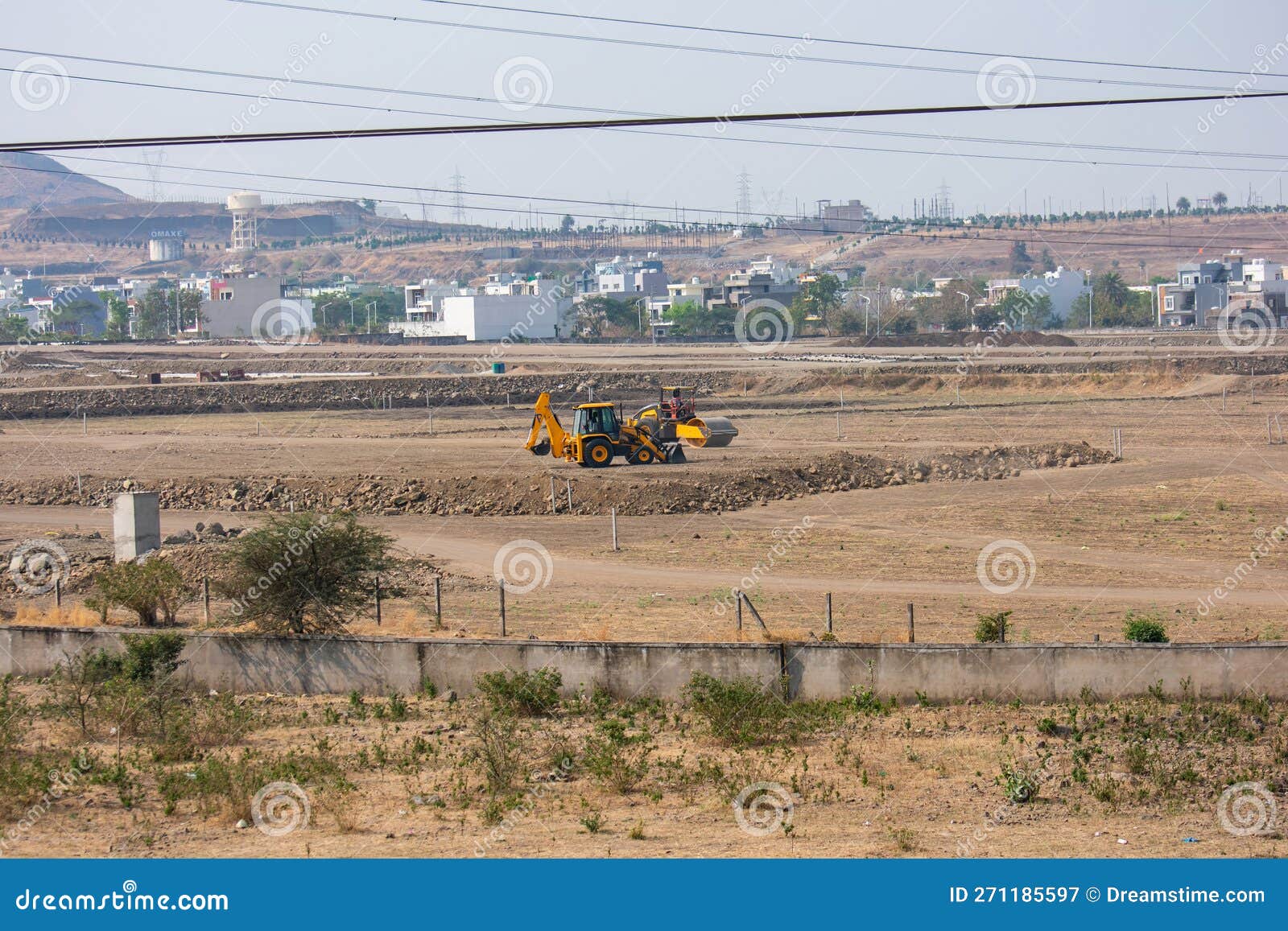 Excavator Backhoe Digger Loader Leveling the Field with Road Roller at ...