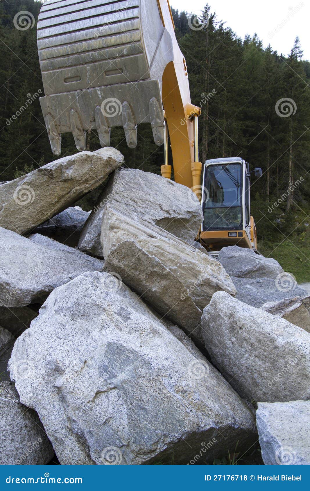Excavator Behind Large Rocks Stock Photo - Image of ground, machinery ...