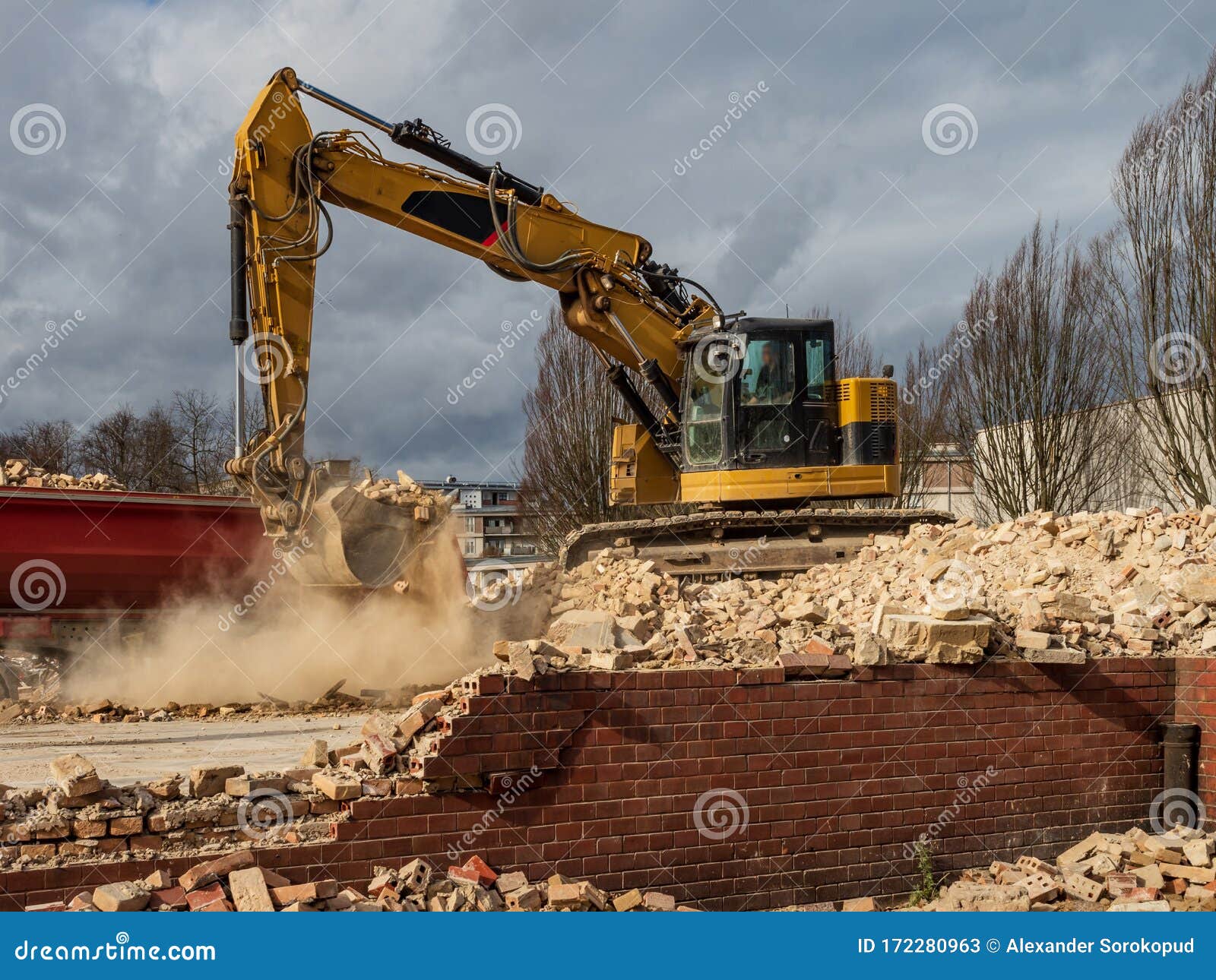 An Excavator Breaks Down an Old Building. Dust, Bricks and Broken Walls ...