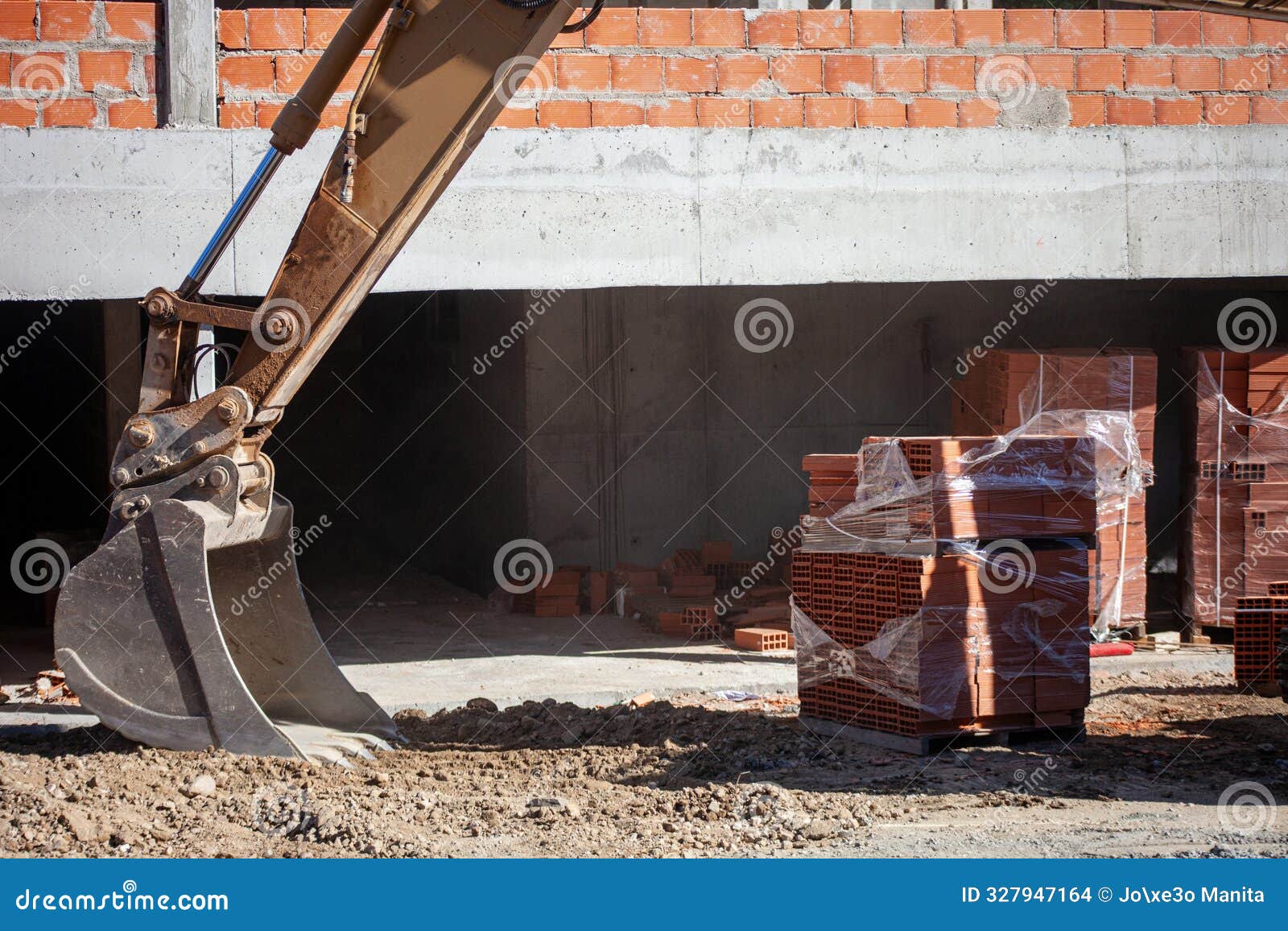 Excavator Bucket beside Bricks at a Renovation Site. Stock Photo ...