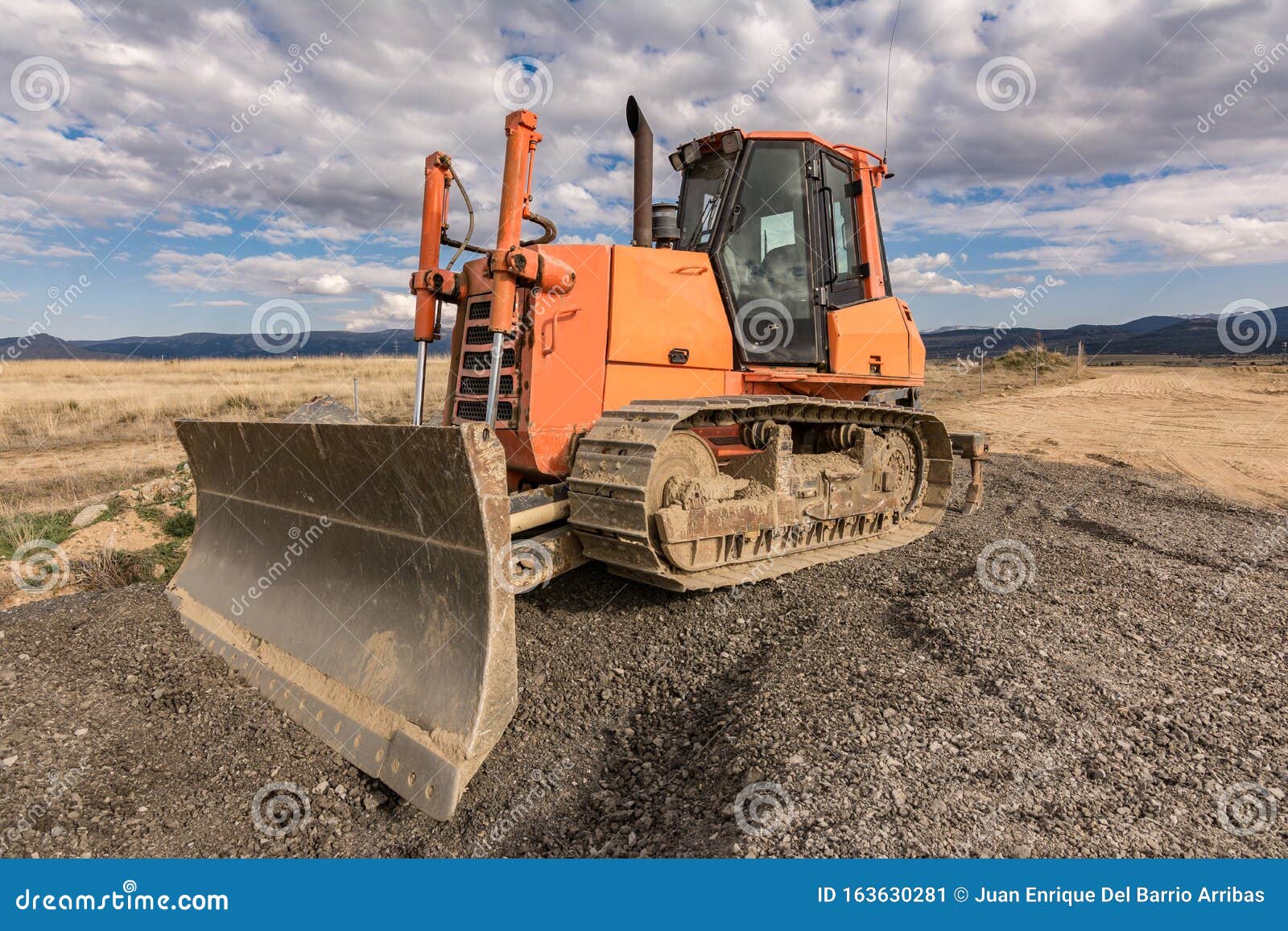 Excavator building a road stock image. Image of field - 163630281