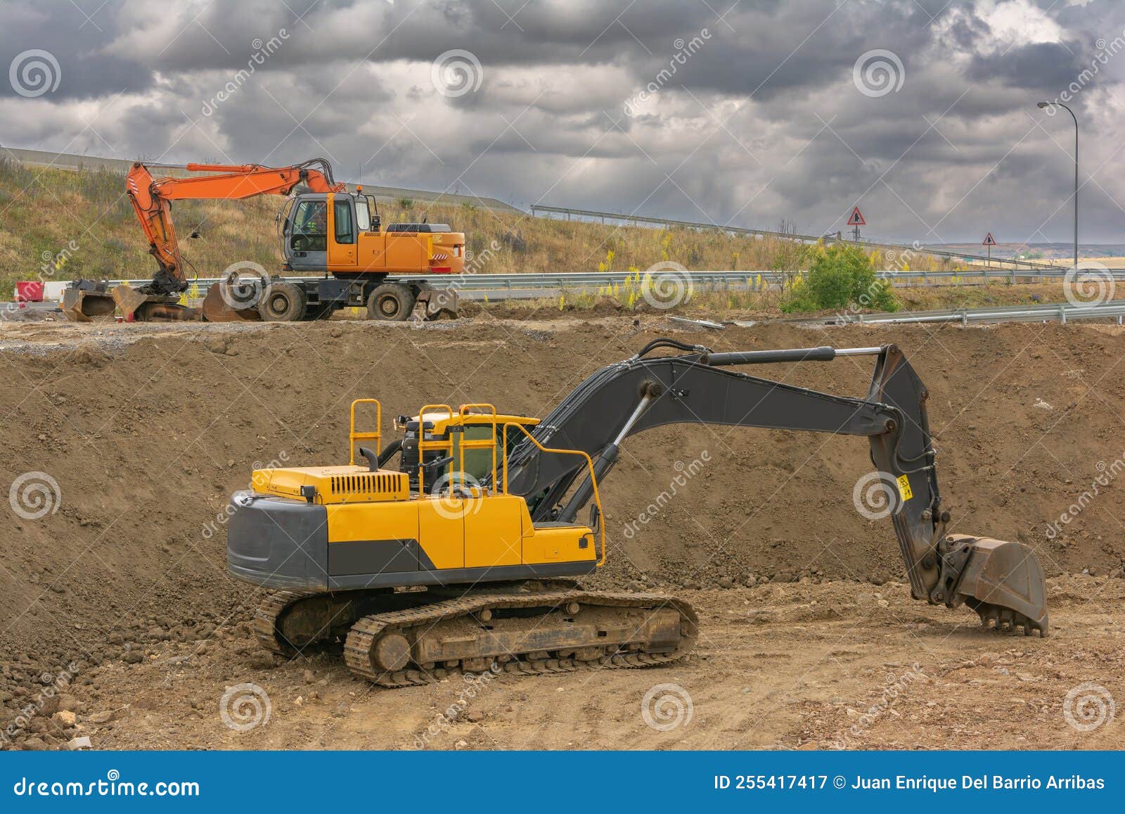 Excavator Building a Road in a Site ConstructionGroup of Excavator ...