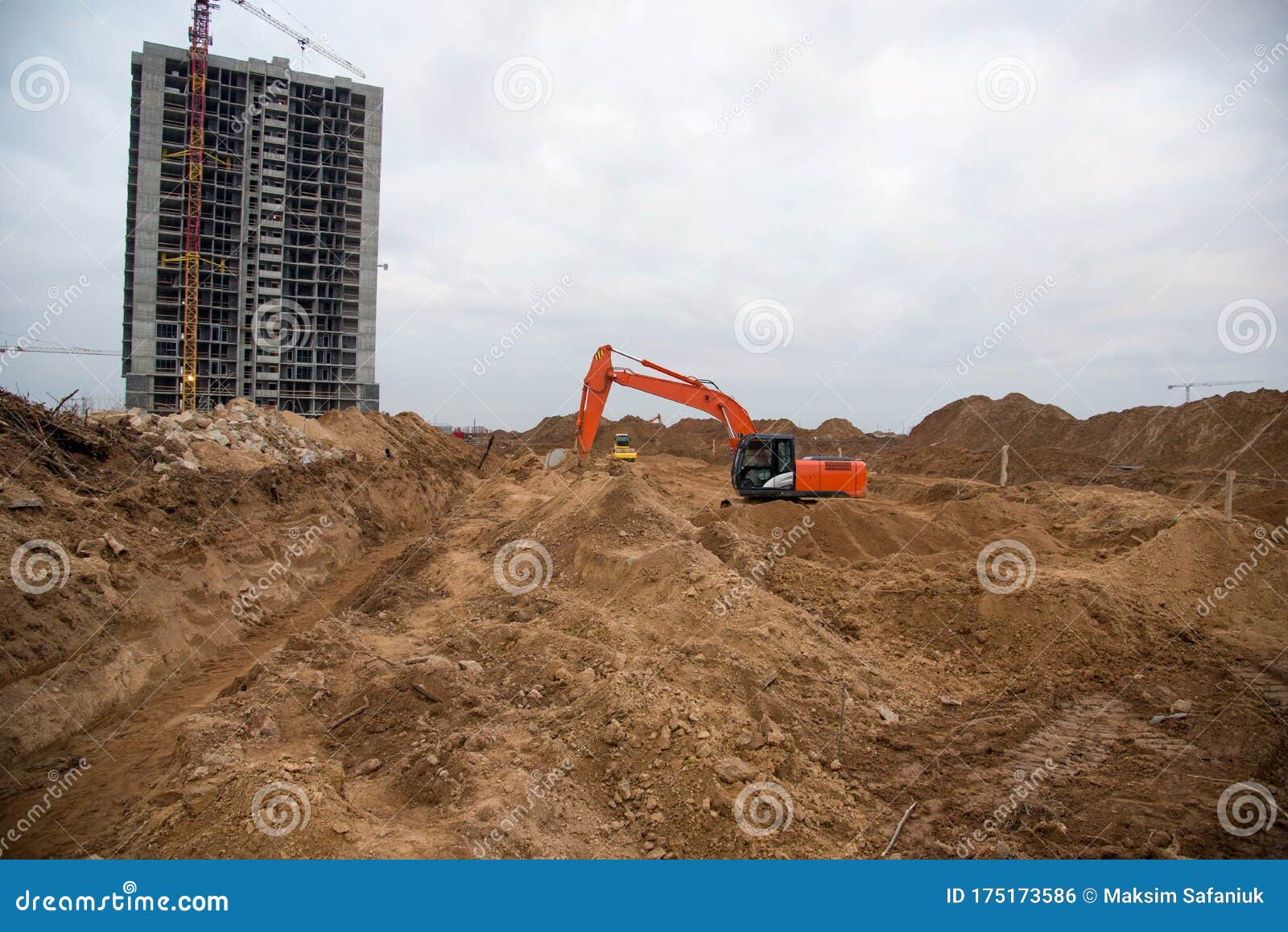 Excavator at Building Under Construction. Backhoe Digs the Ground for ...