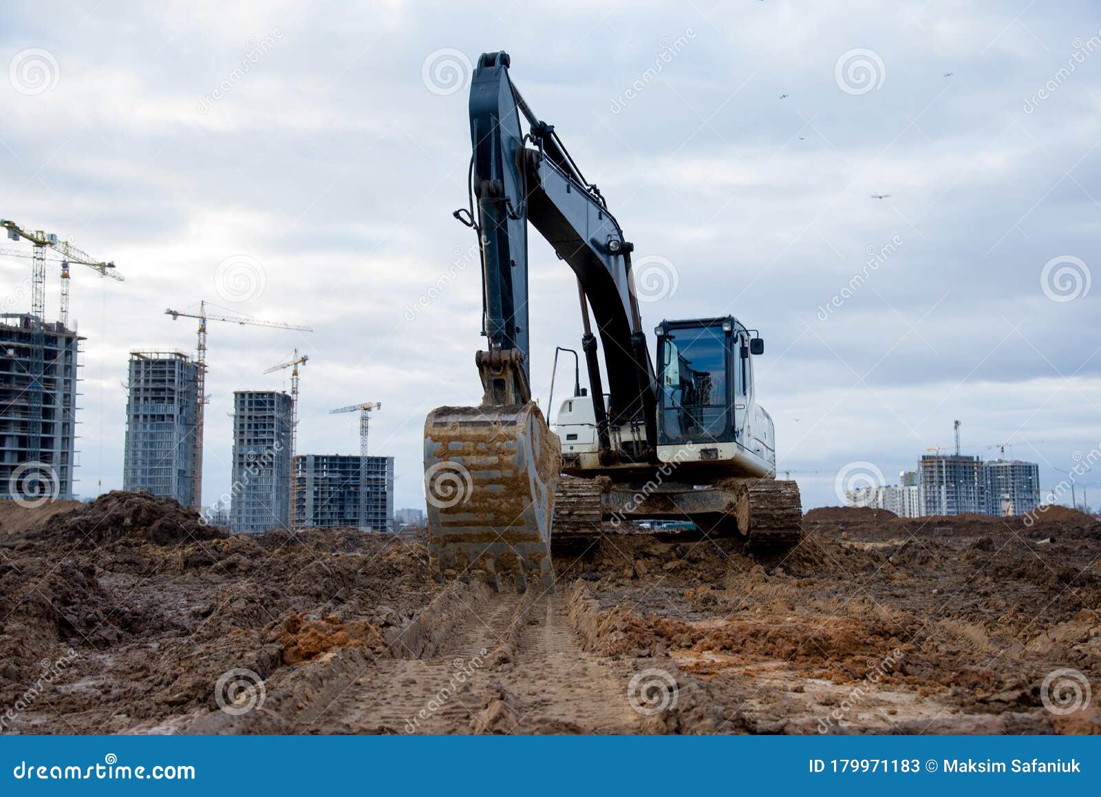 Excavator at Building Under Construction. Backhoe Digs the Ground for ...