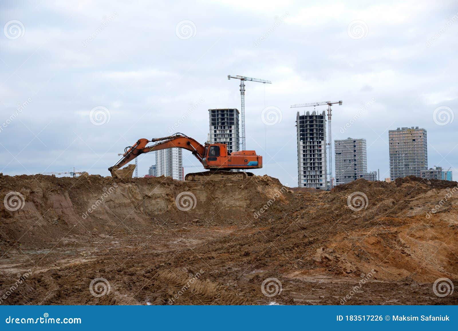 Excavator at Building Under Construction. Backhoe Digs the Ground for ...