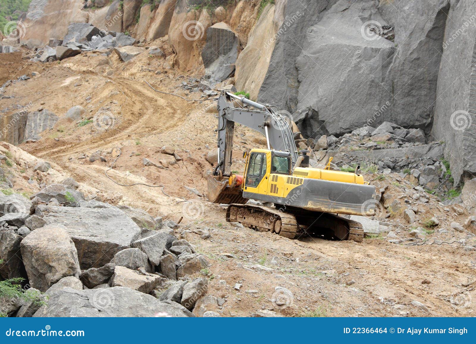 An Excavator Carrying a Oil Drum in a Granite Mine Stock Photo - Image ...