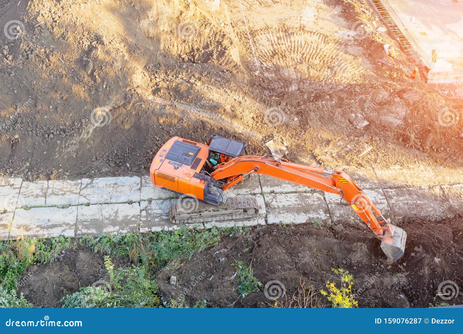 Excavator on Caterpillars in the Foundation Pit during the Construction ...