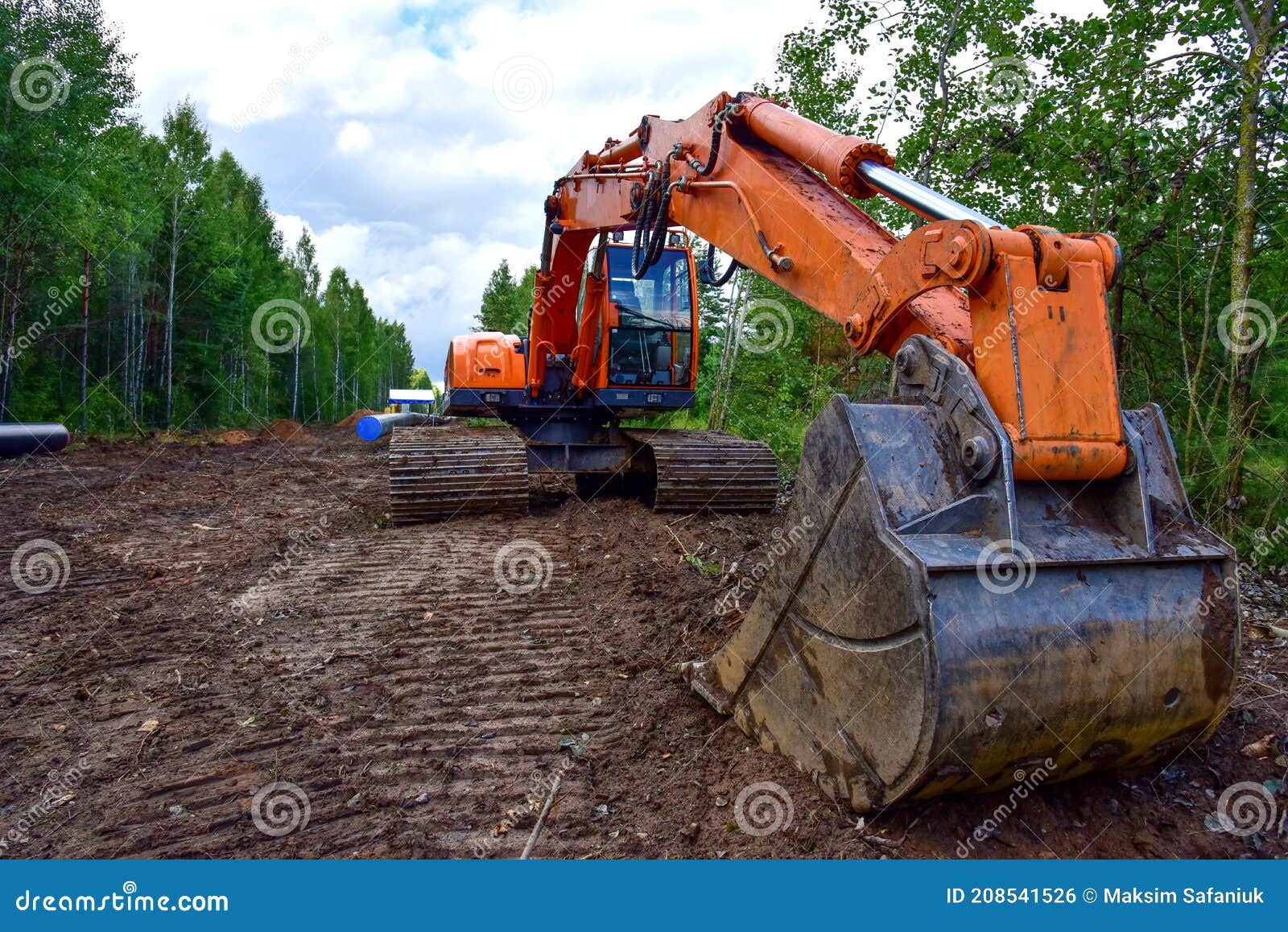 Excavator Clearing Forest for New Development. Orange Backhoe Modified ...