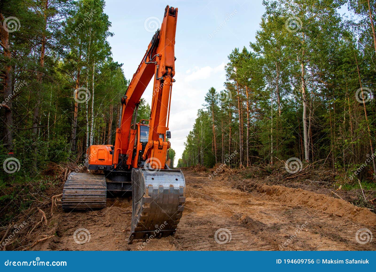Excavator Clearing Forest for New Development. Orange Backhoe Modified ...