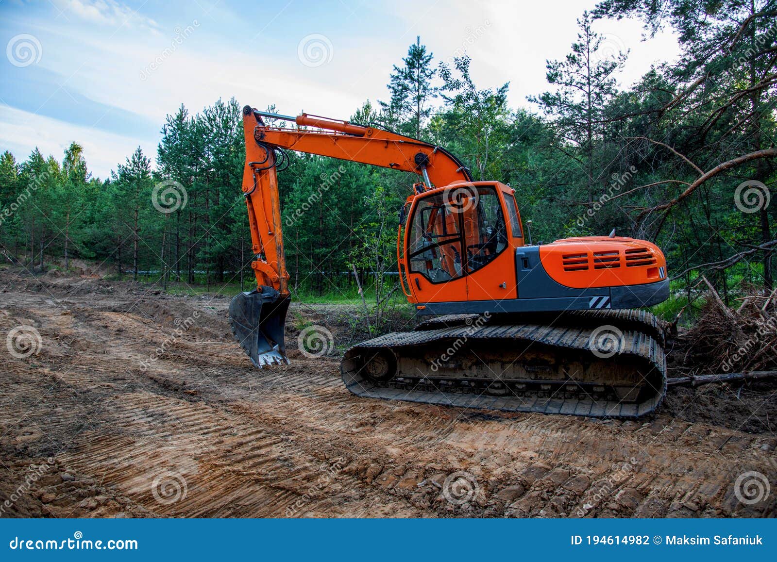 Excavator Clearing Forest for New Development. Orange Backhoe Modified ...