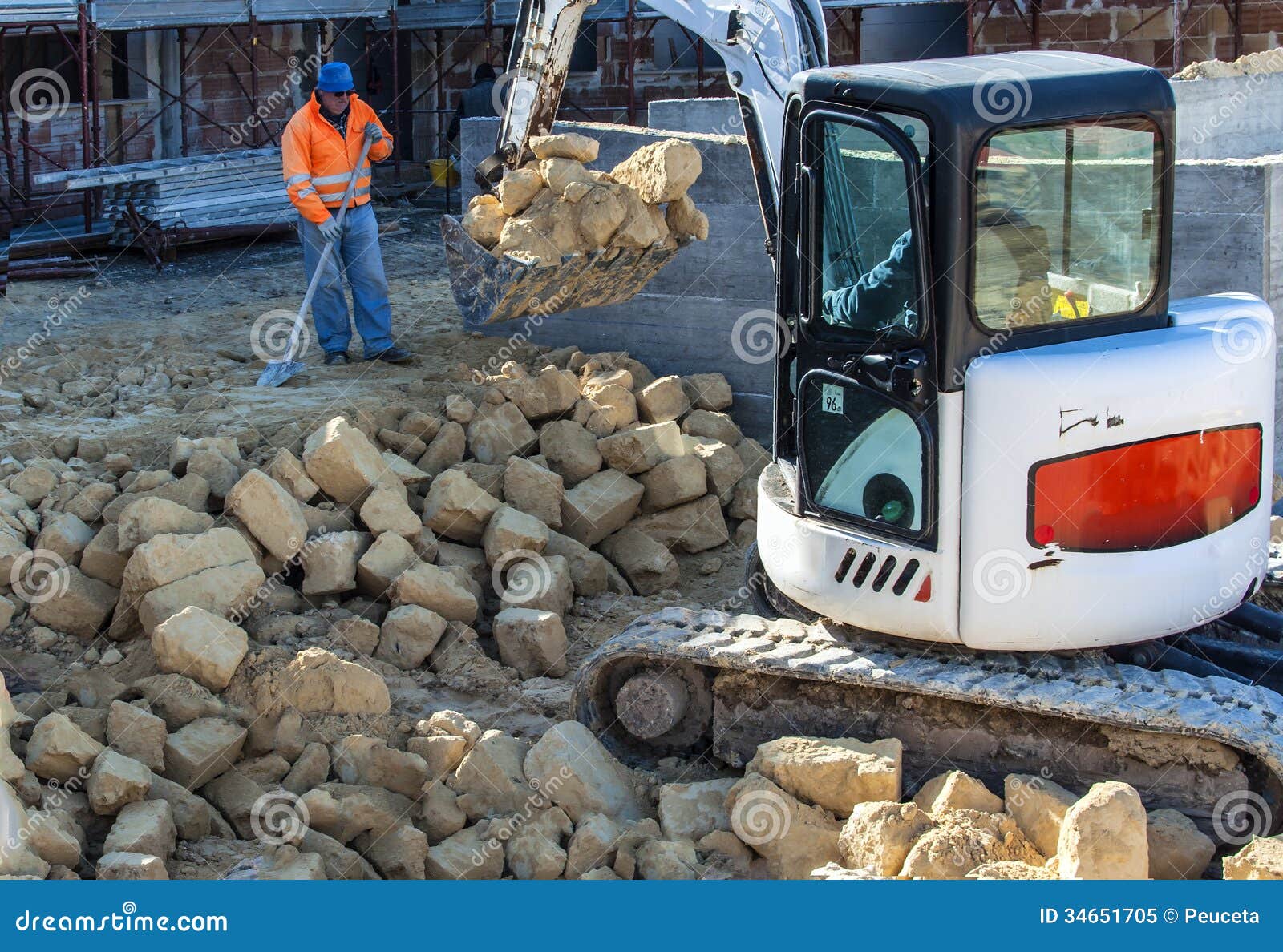 Excavator Compact Inert Material with the Assistance of a Worker Stock ...