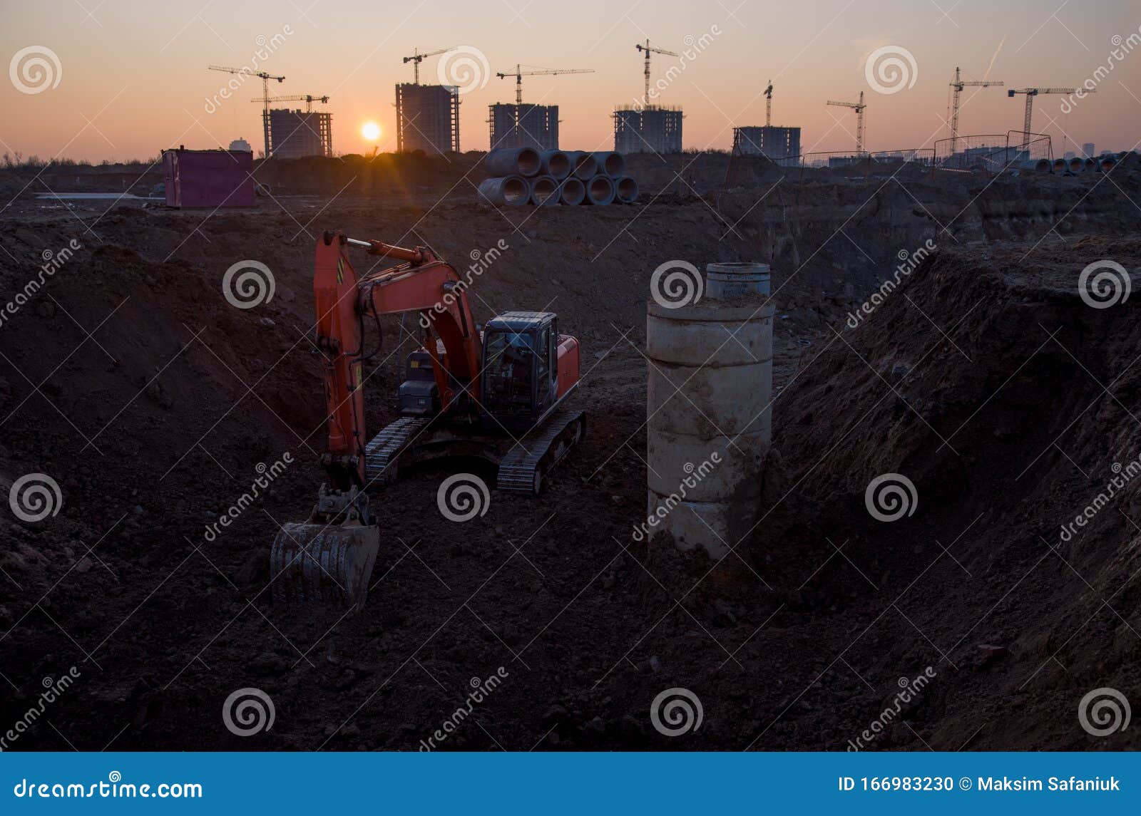 Excavator at a Construction Site on a Background of a Construction ...