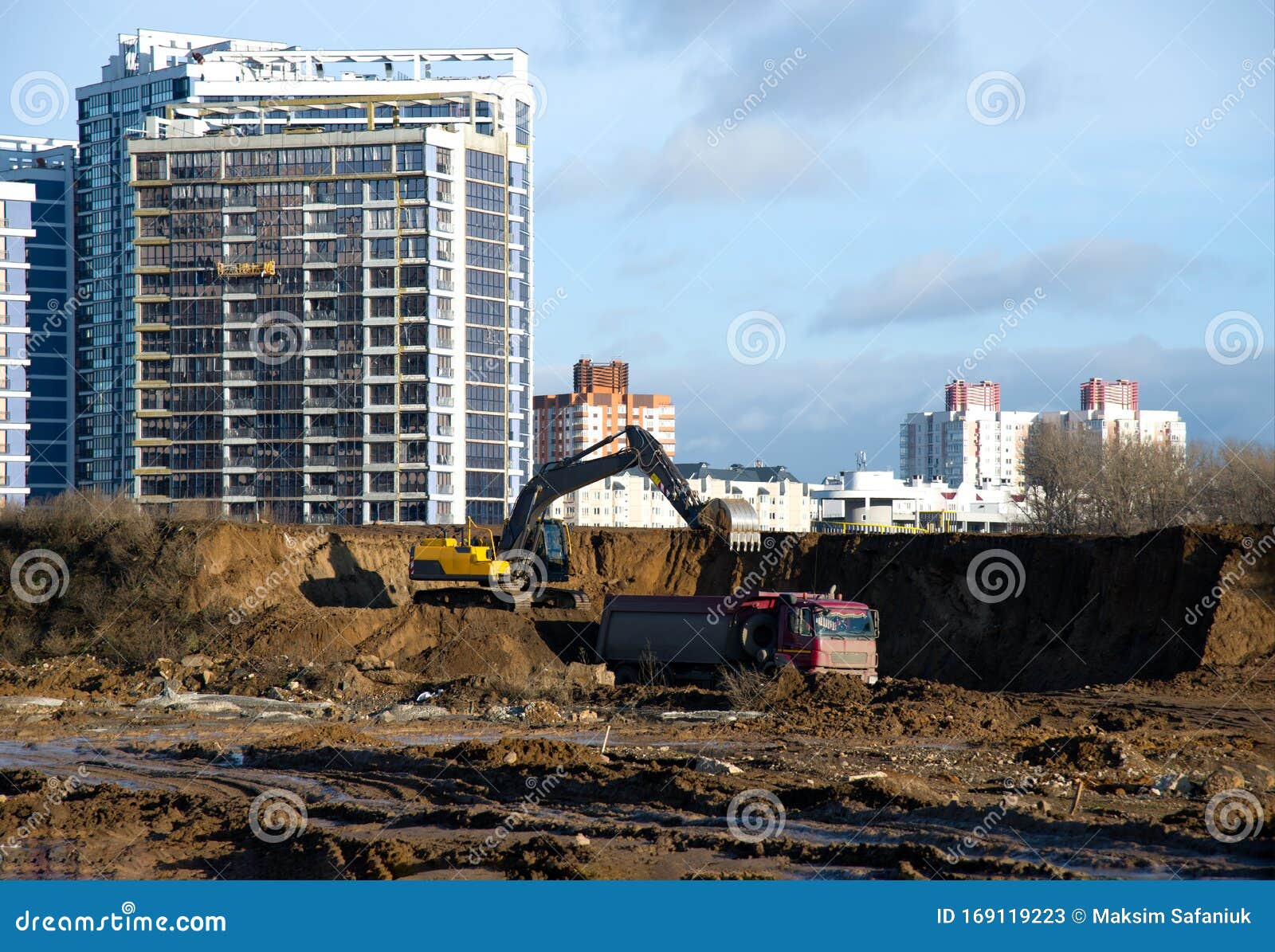 Excavator at a Construction Site on a Background of a Construction ...